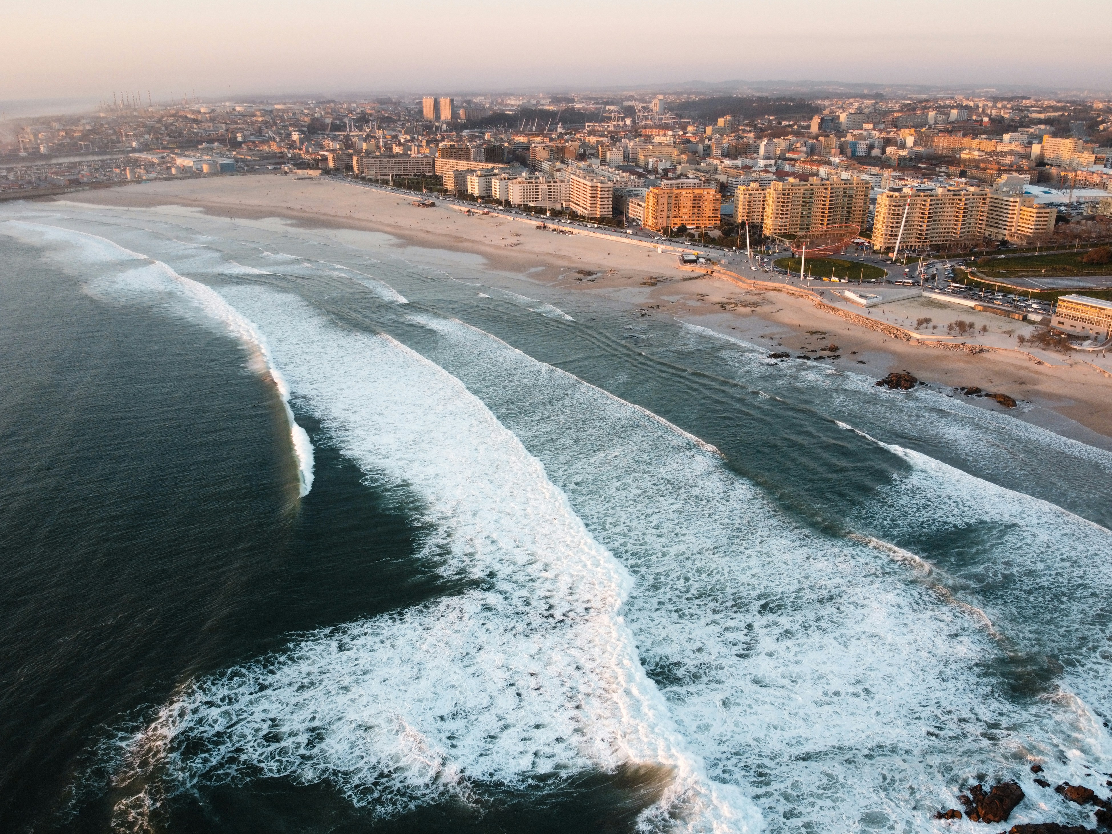 Foam Lattice Along the Beachfront: A Drone View of Waves and City Blocks