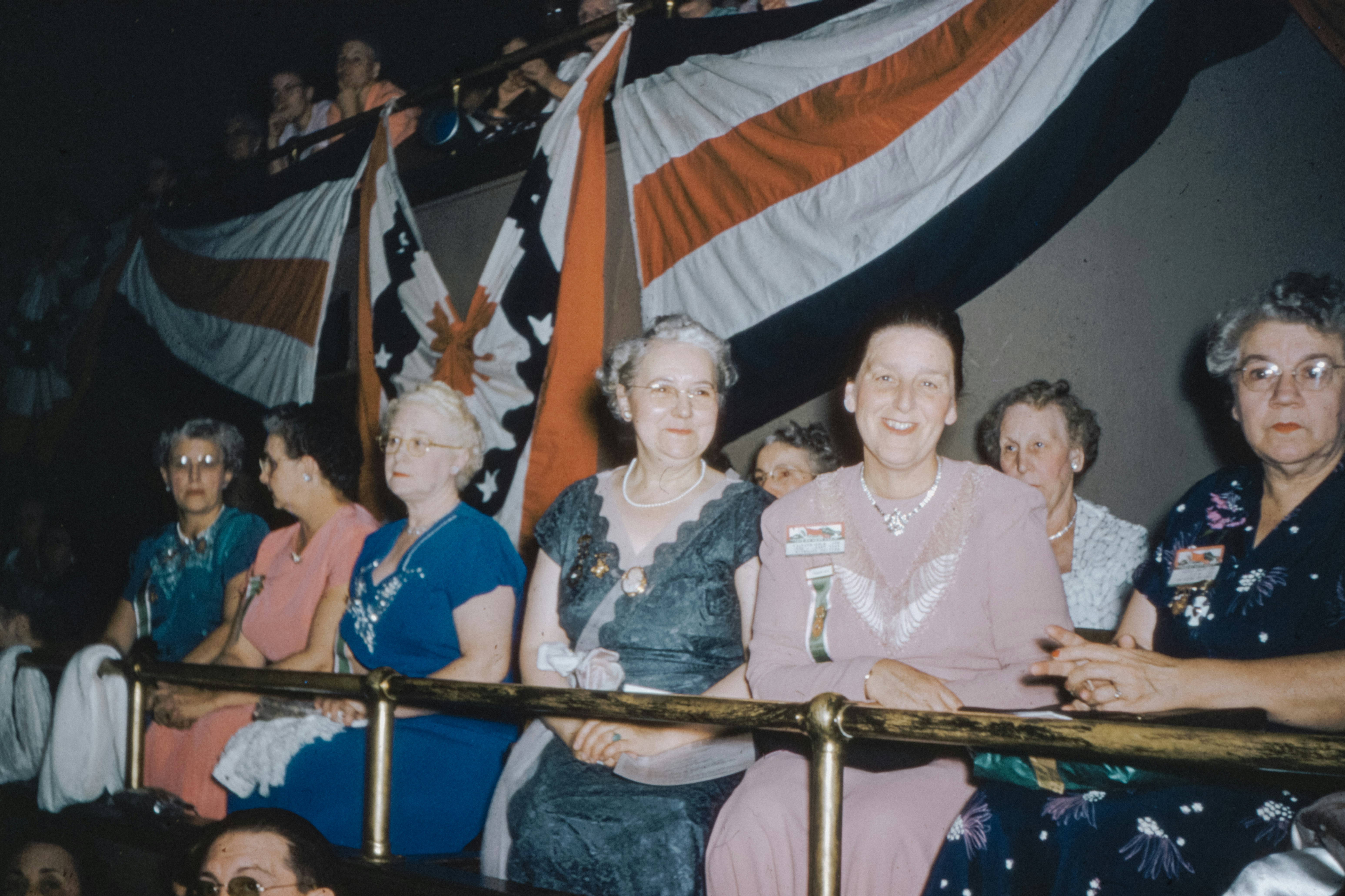 Gold-Rimmed Audience: A Moment at the Balcony Rail