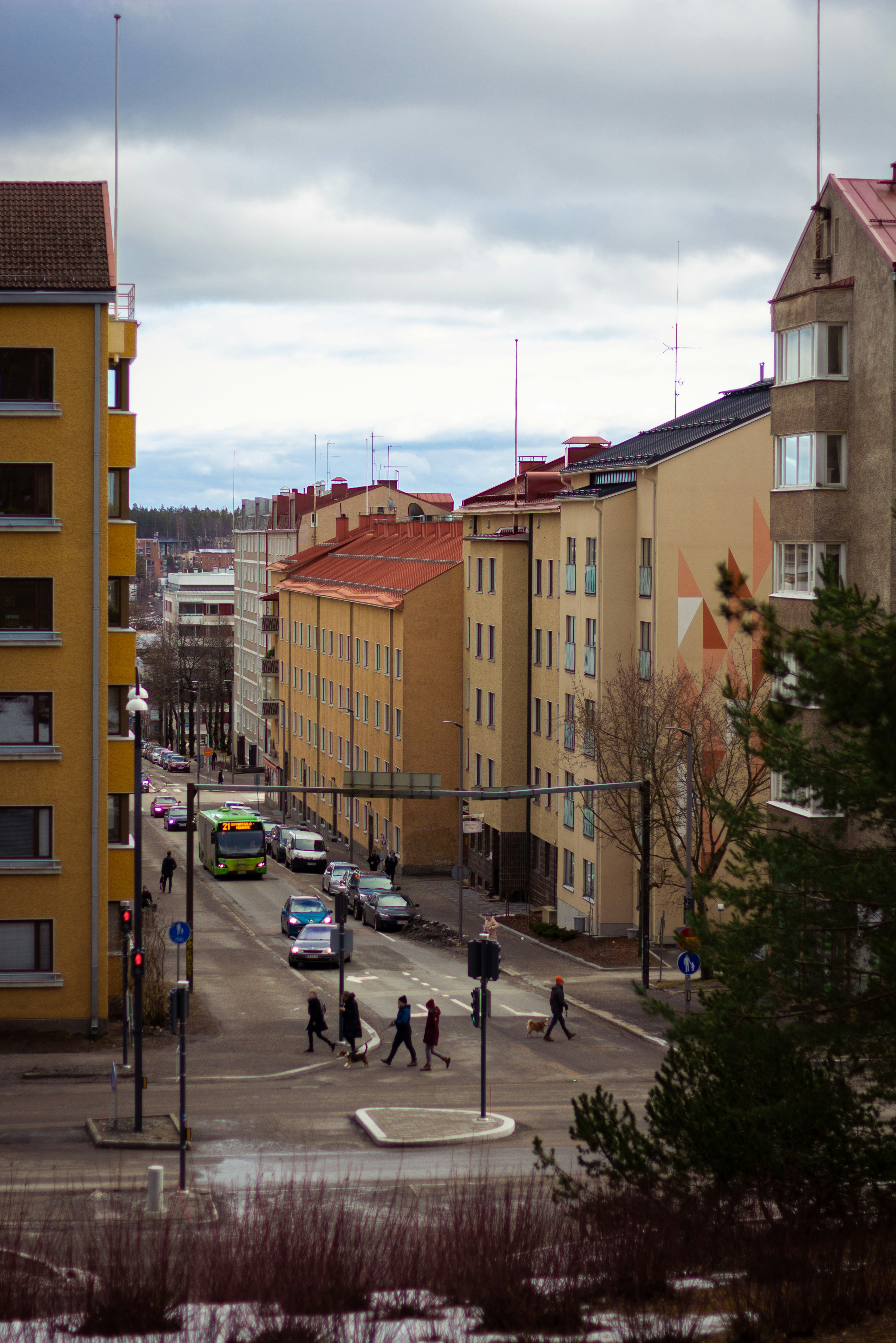 A city street with pedestrians and cars.