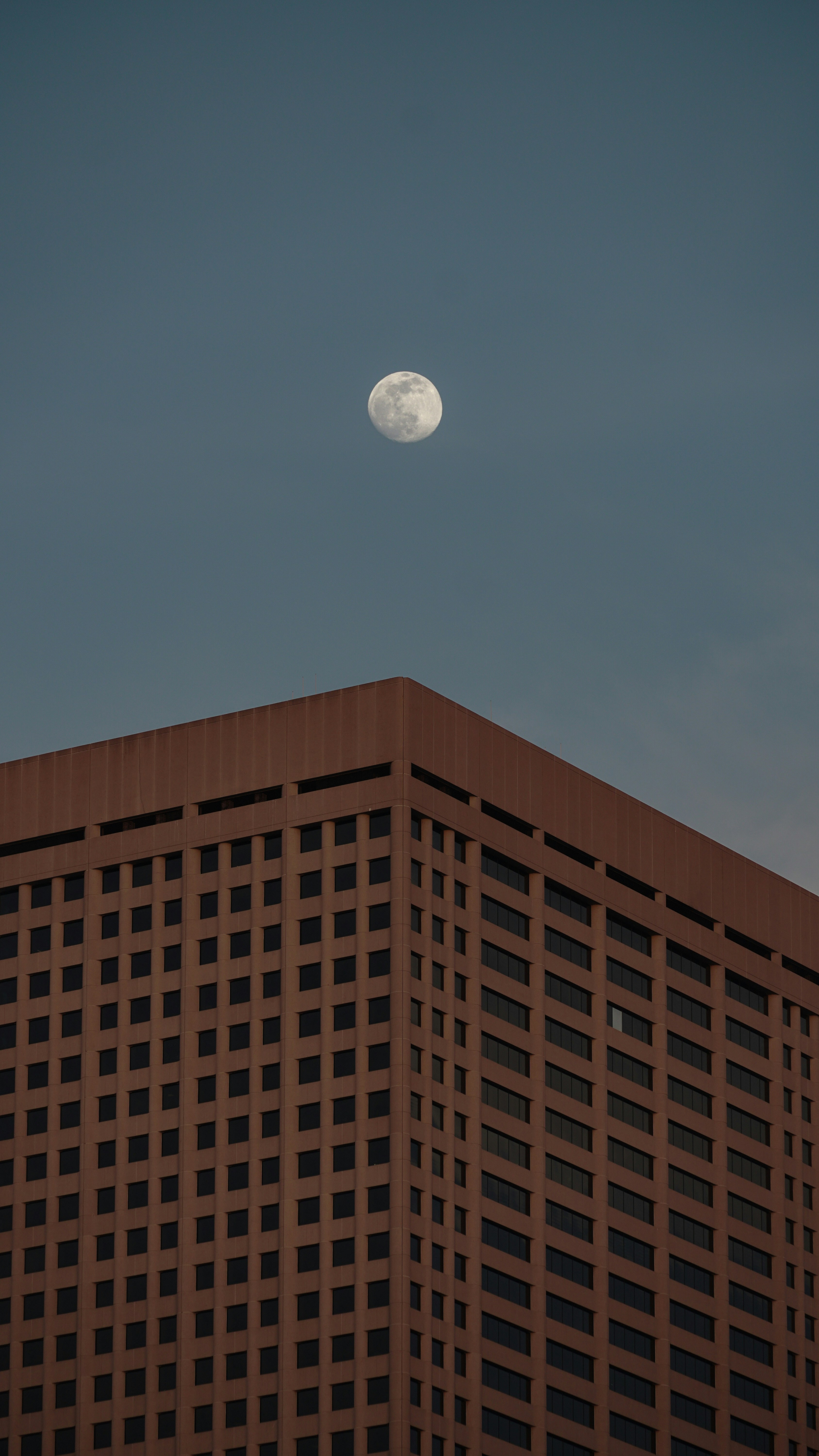 Moon Over the Terracotta Skyscraper at Dusk