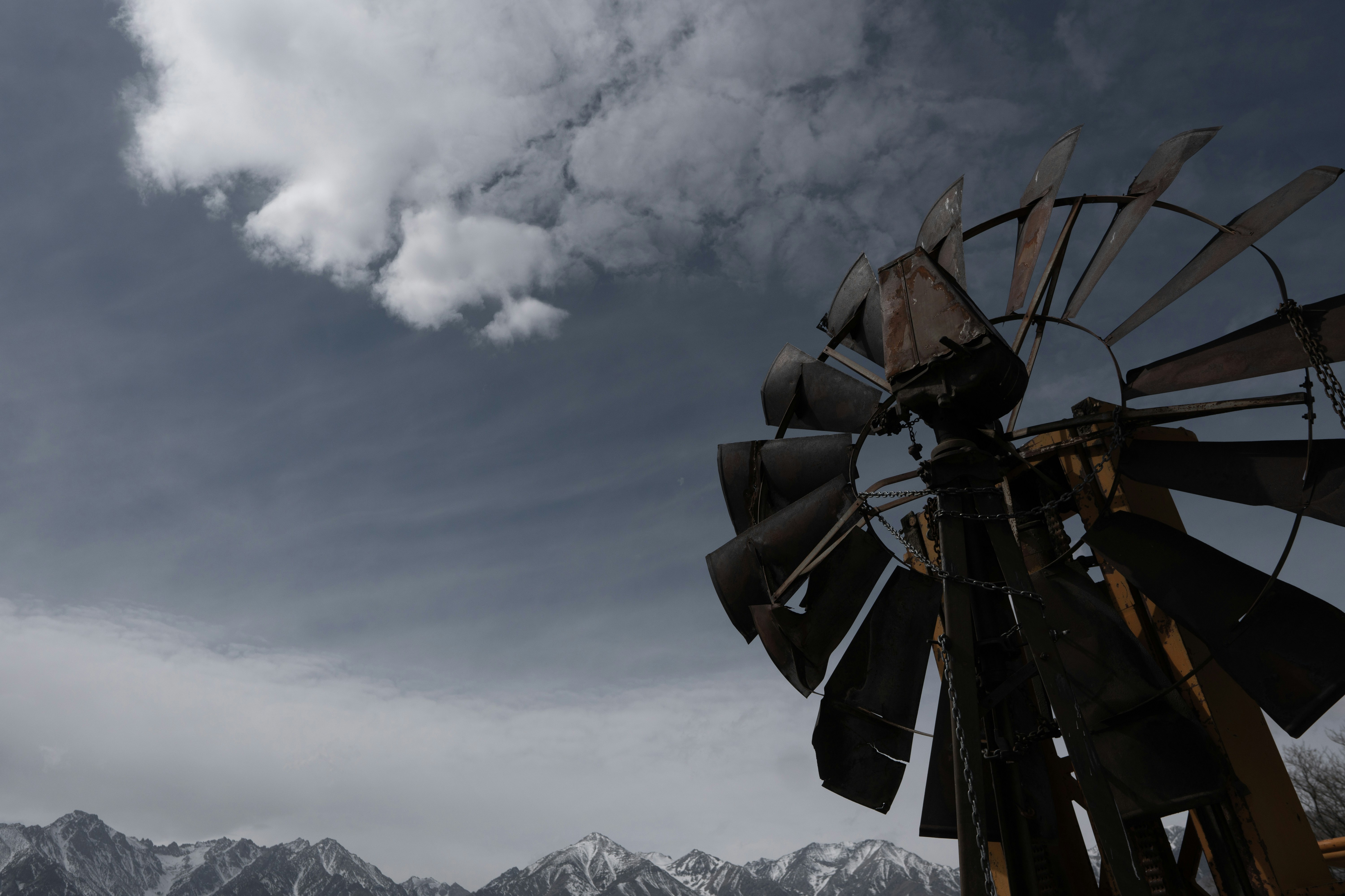 Windmill Contrapuntal against Snow-Crowned Peaks