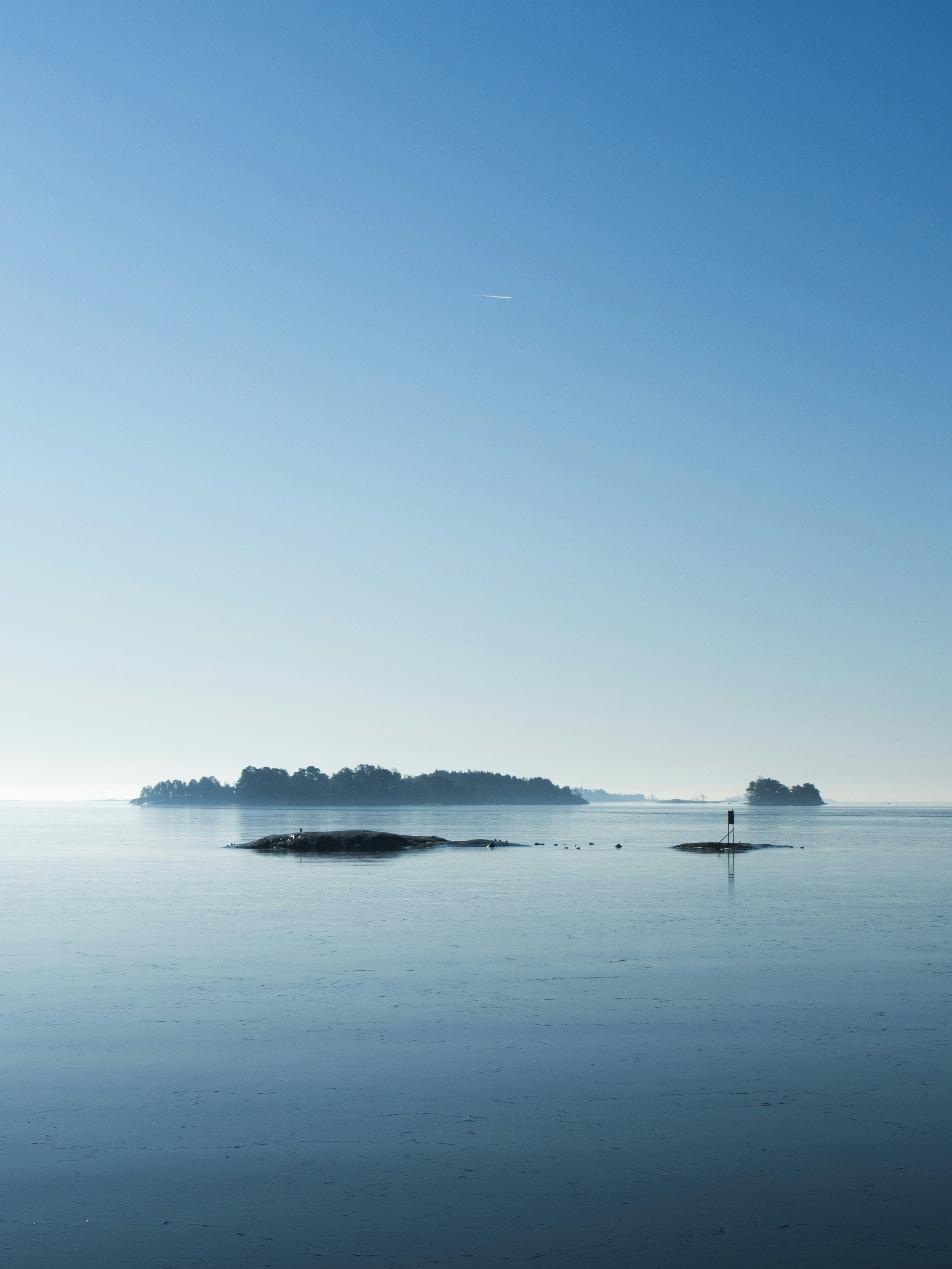 Silenced Horizon: A Quiet Isle Drifts in Blue Serenity
