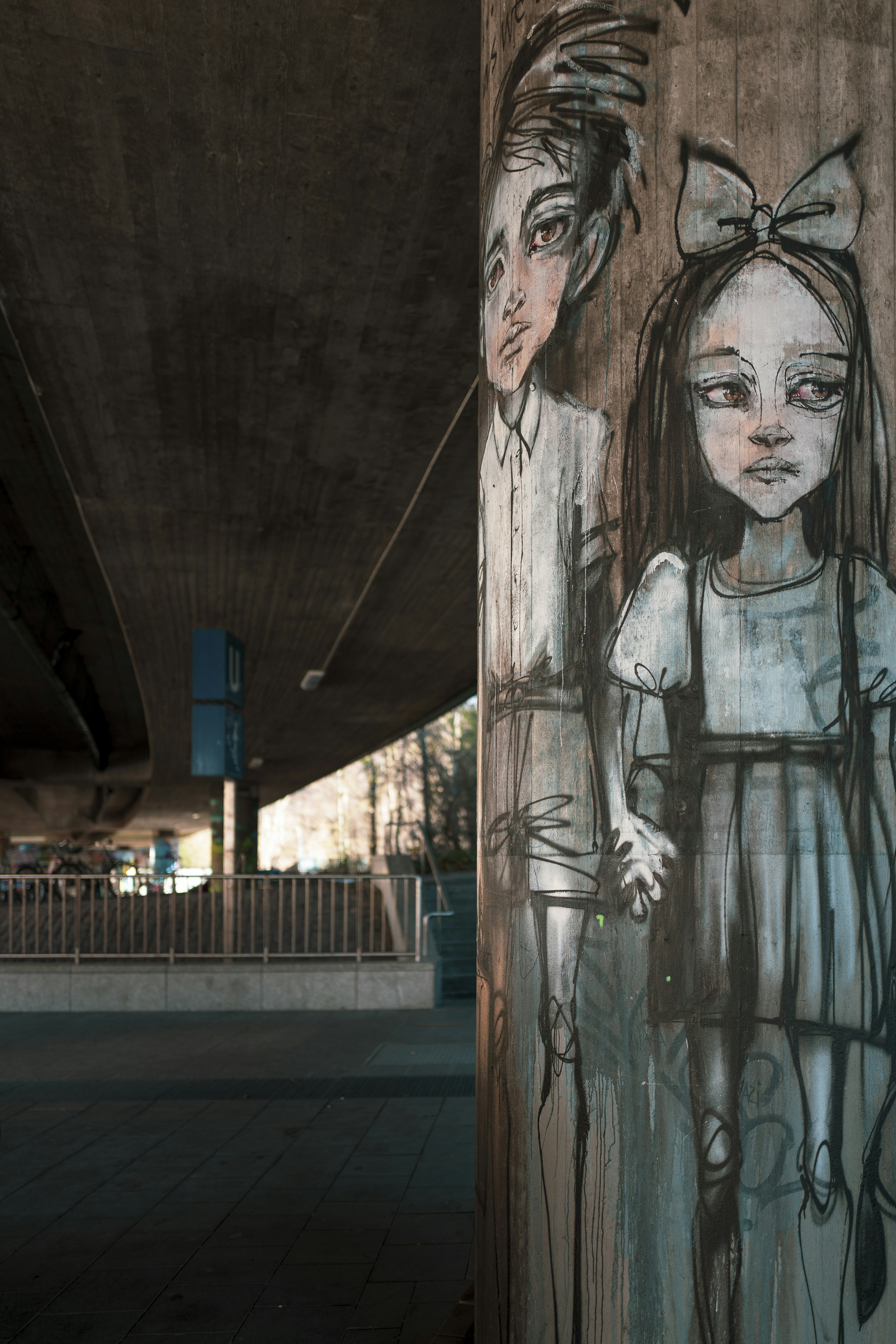 Concrete Portraits: Two Dreamers on a Weathered Pillar