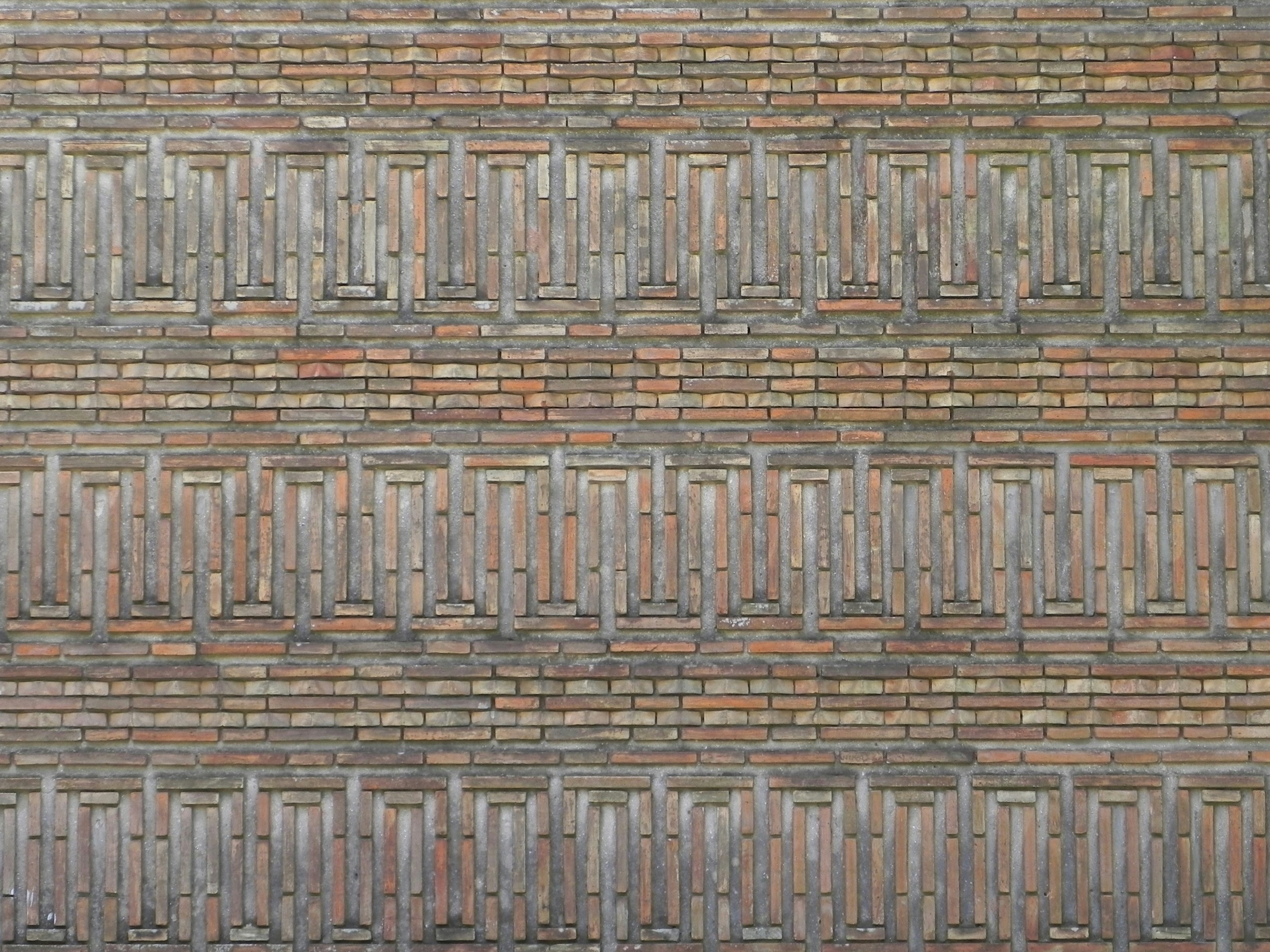 Intricate arrangement of bricks showcasing a rhythmic pattern and texture on a wall surface.