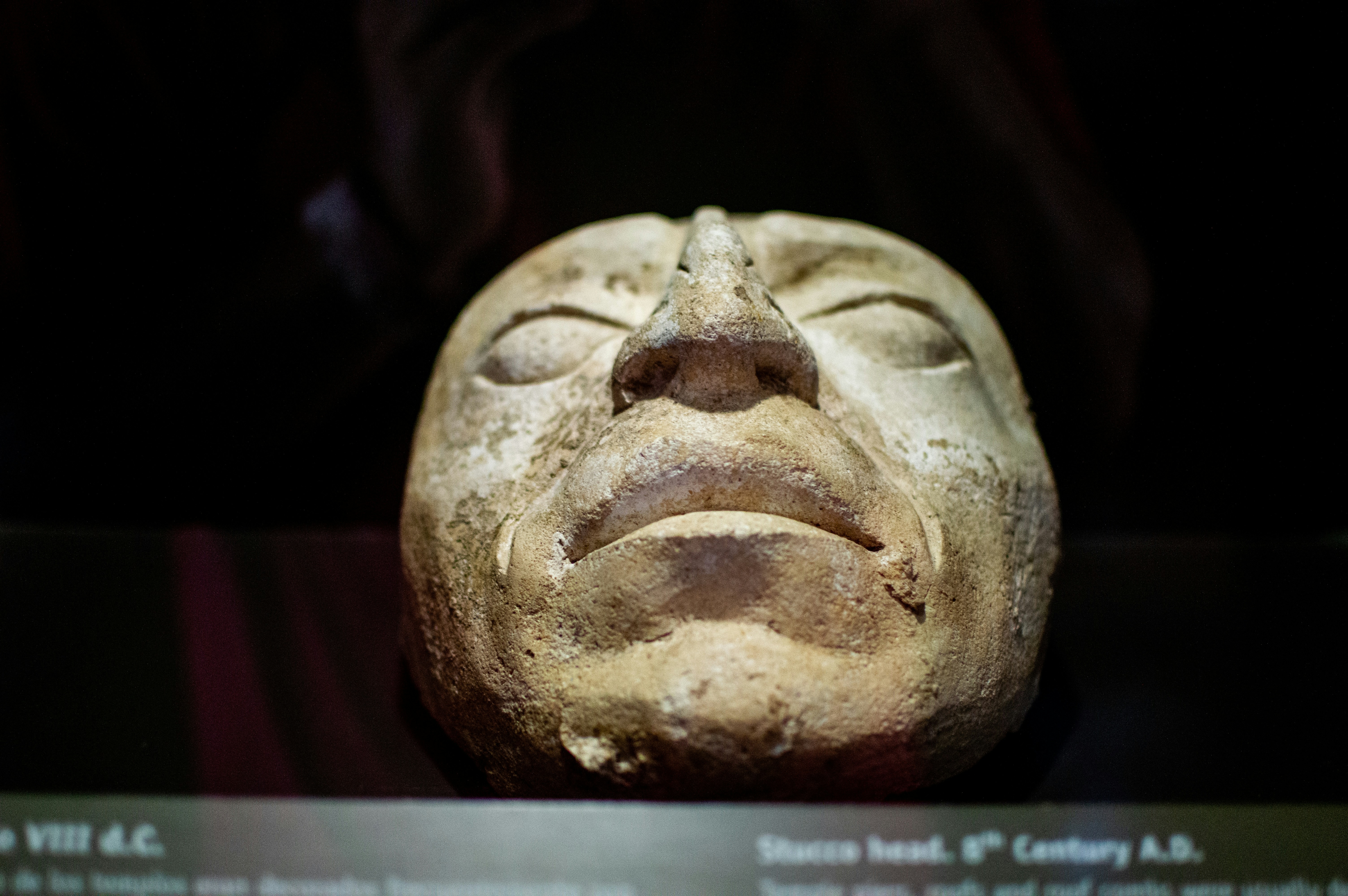 Solemn Stone Mask Under Museum Glass