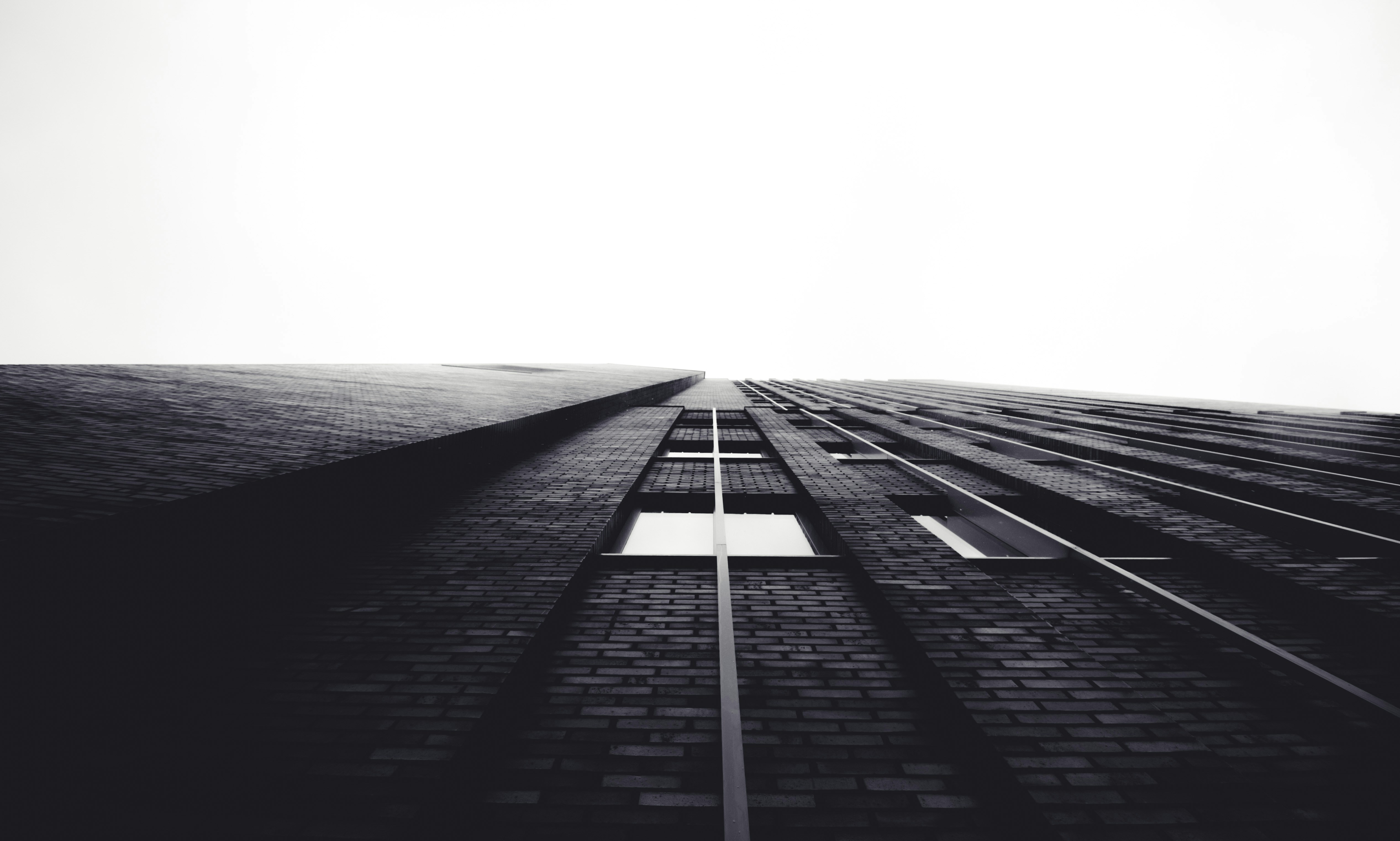 Skyward Convergence: A Brick Facade Reaching the Vanishing Point