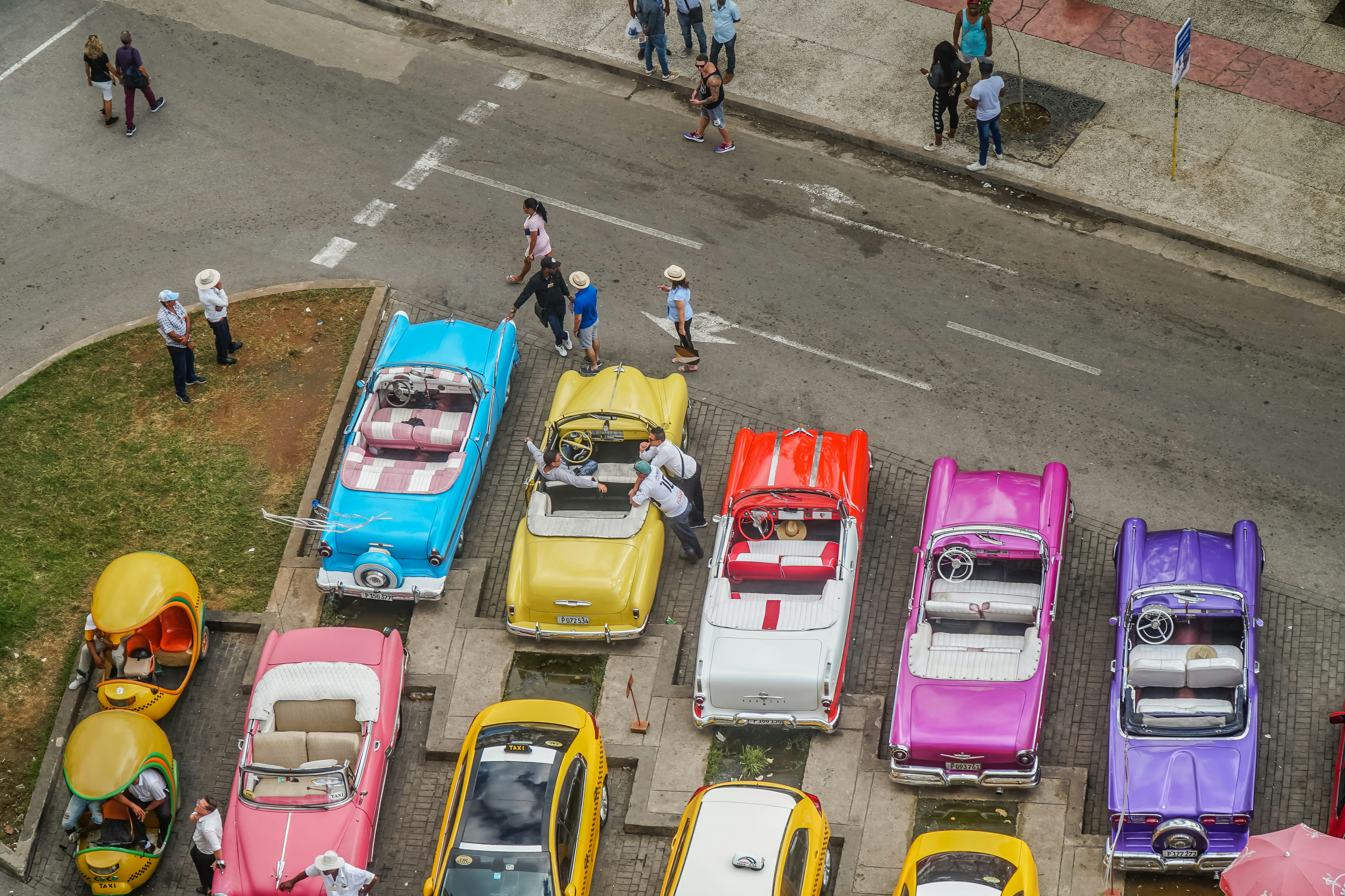 Pastel Parade: Aerial Row of Vintage Convertibles on a City Street