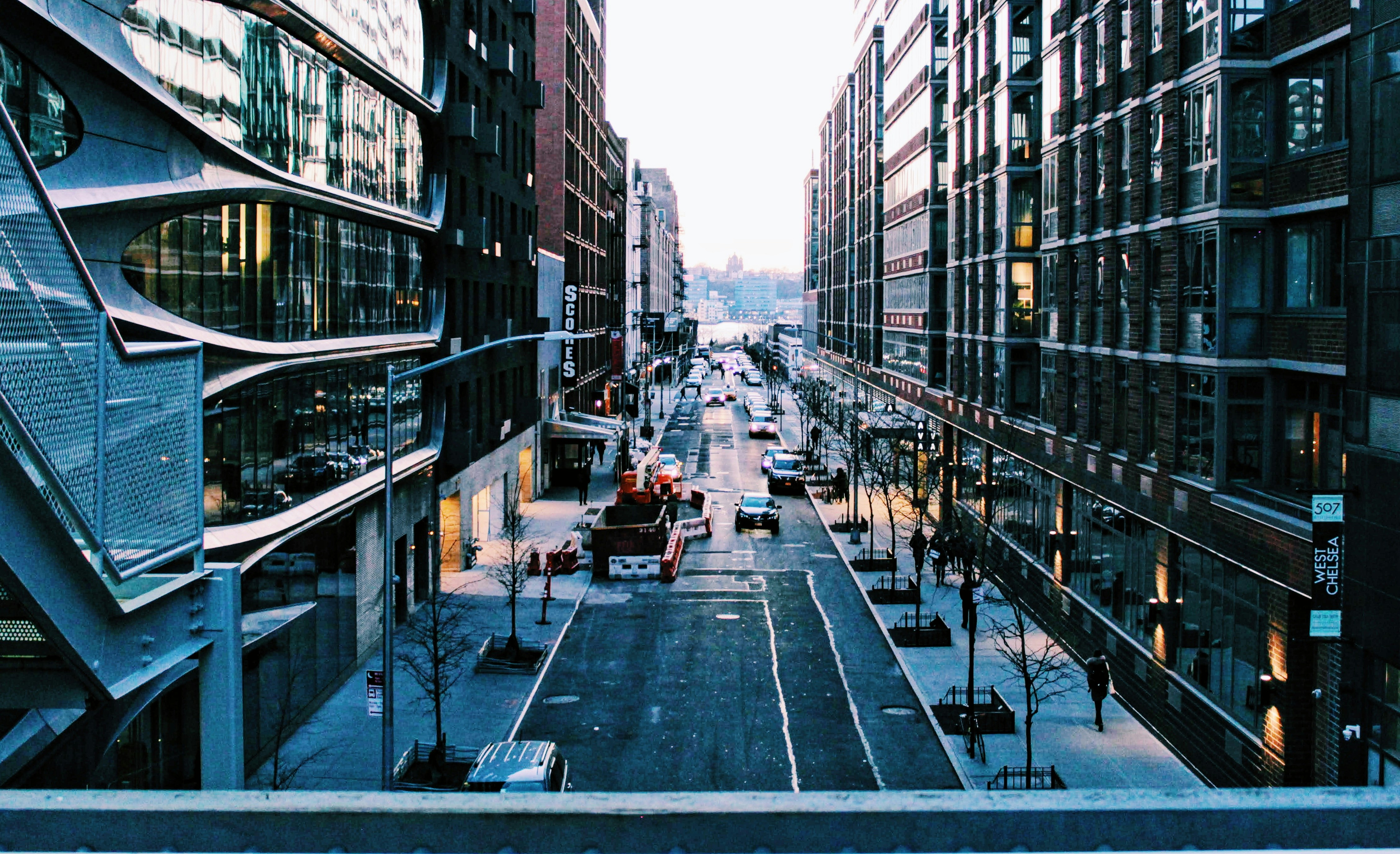 People walking on pedestrian lane in between high rise buildings during ...