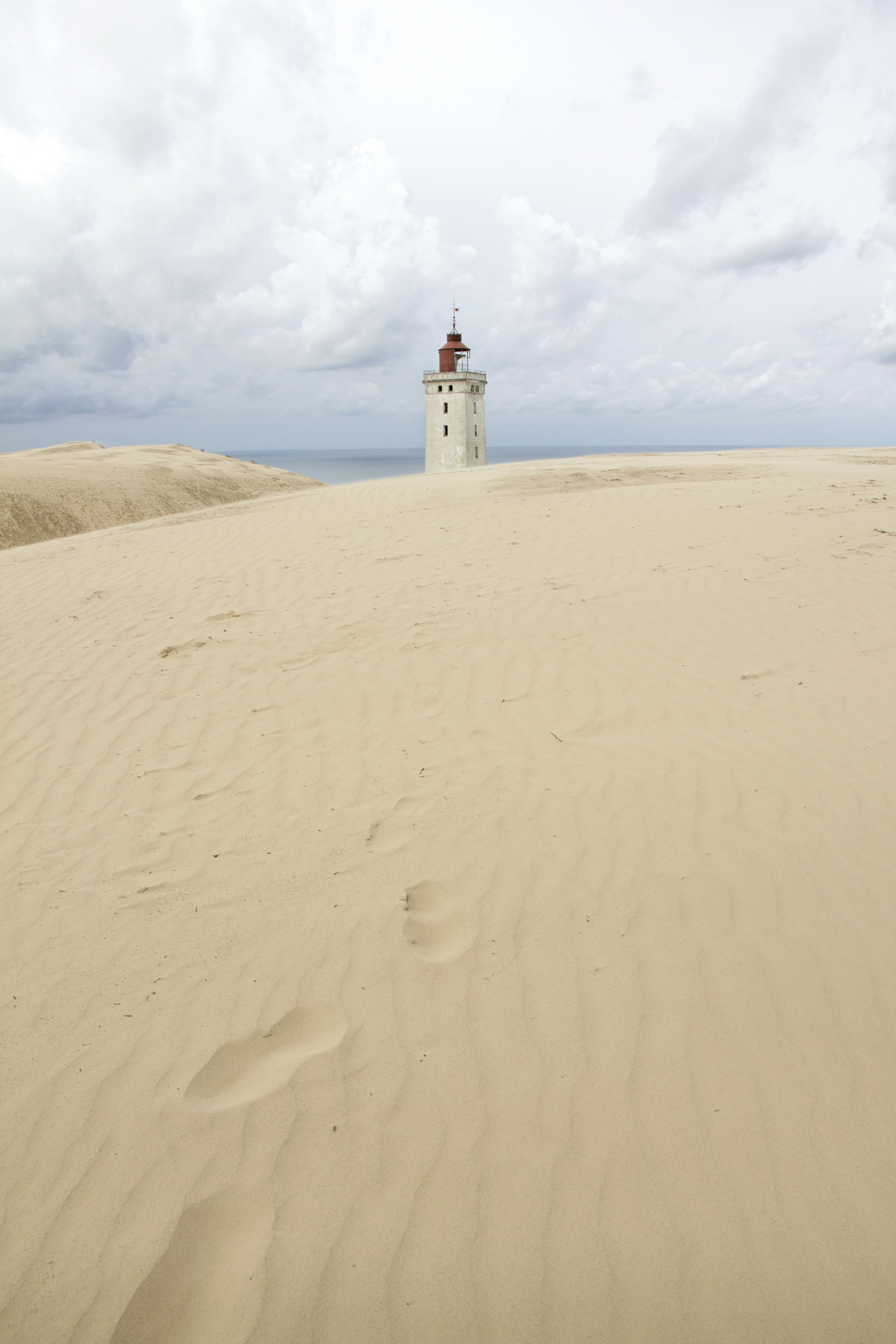 White and red lighthouse on white sand during daytime photo – Free ...