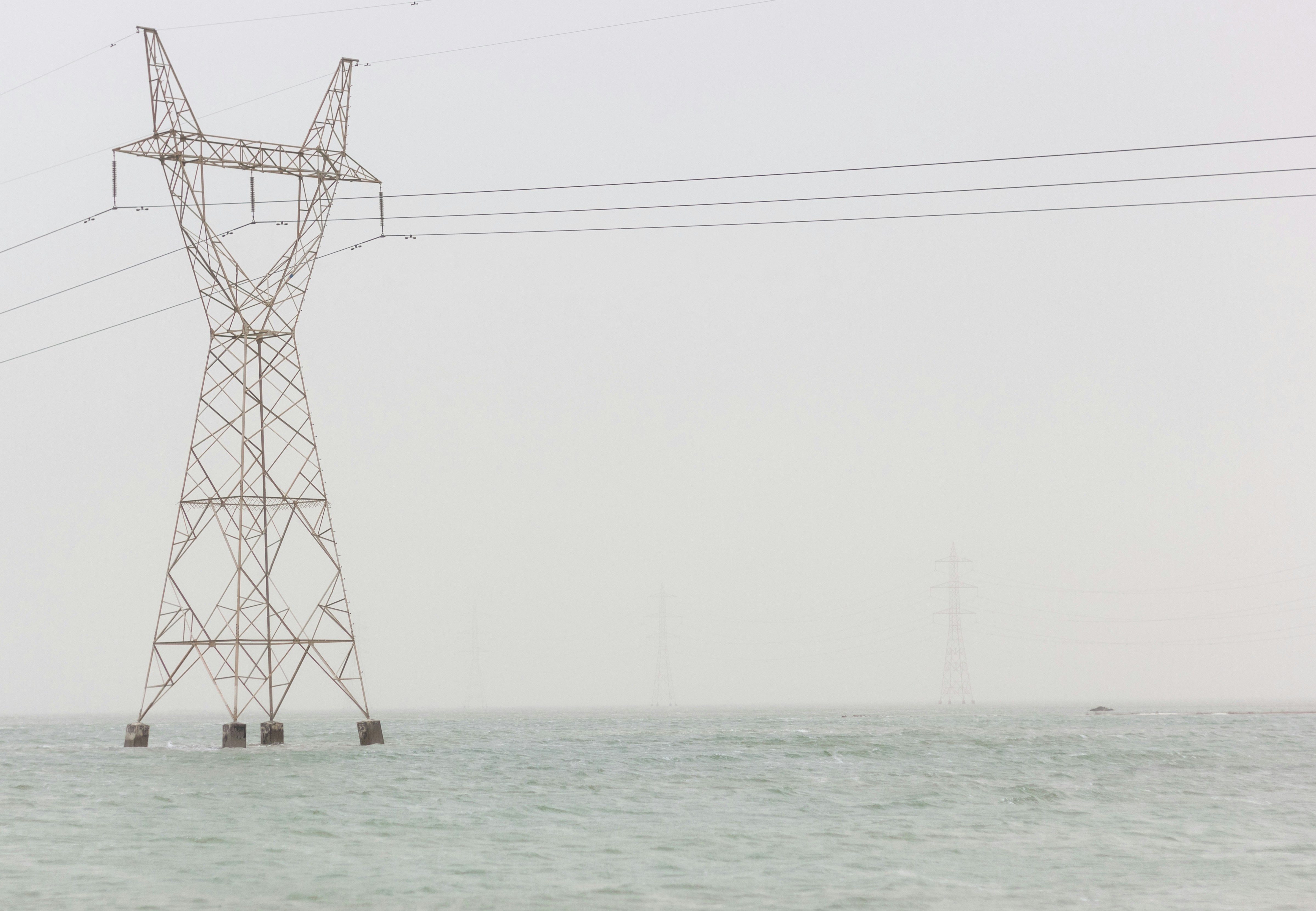 Mist-Soaked Beams: A Lone Lattice Tower Across a Quiet Sea
