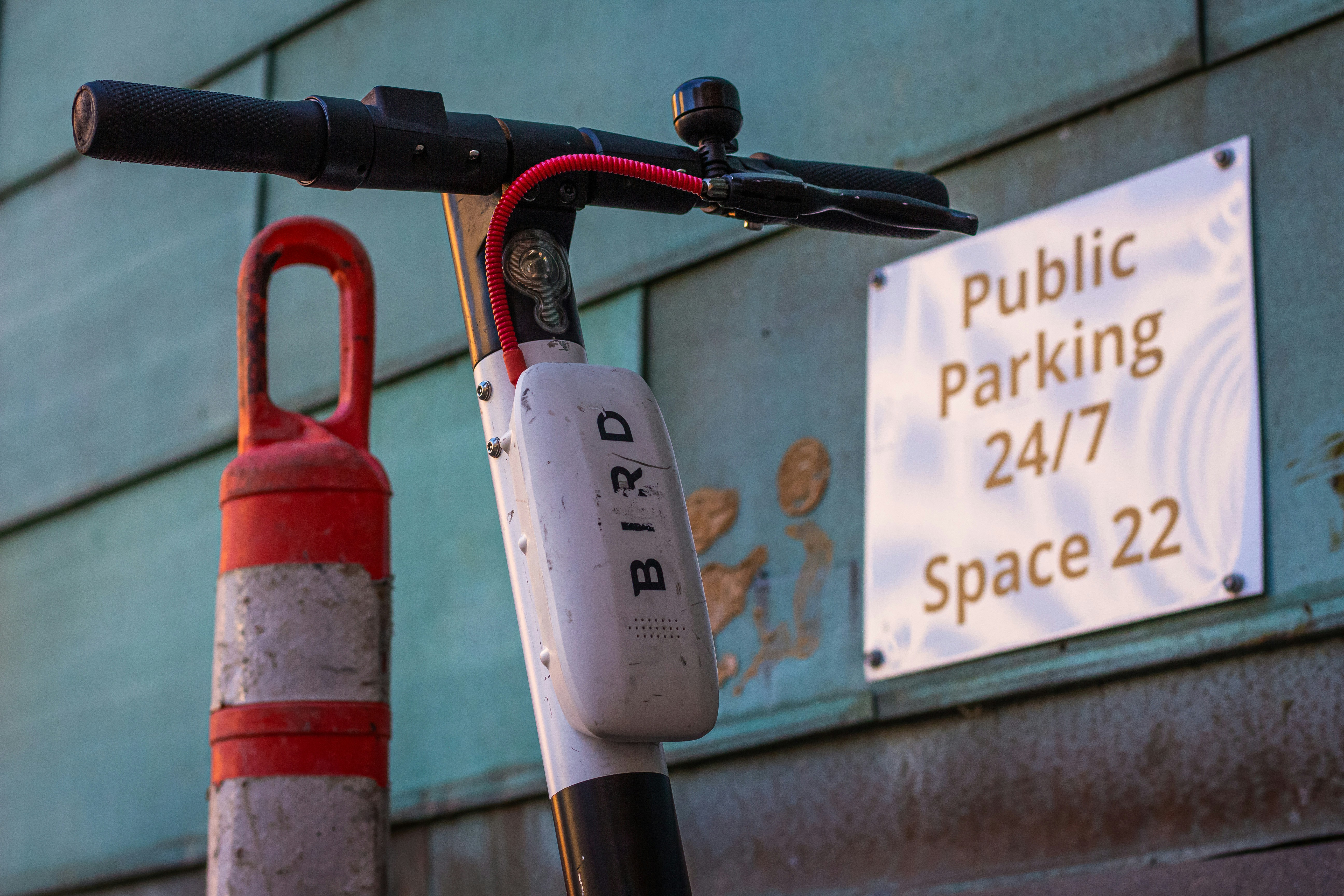 Urban Scooter by the Wall: Public Parking Sign in the Background