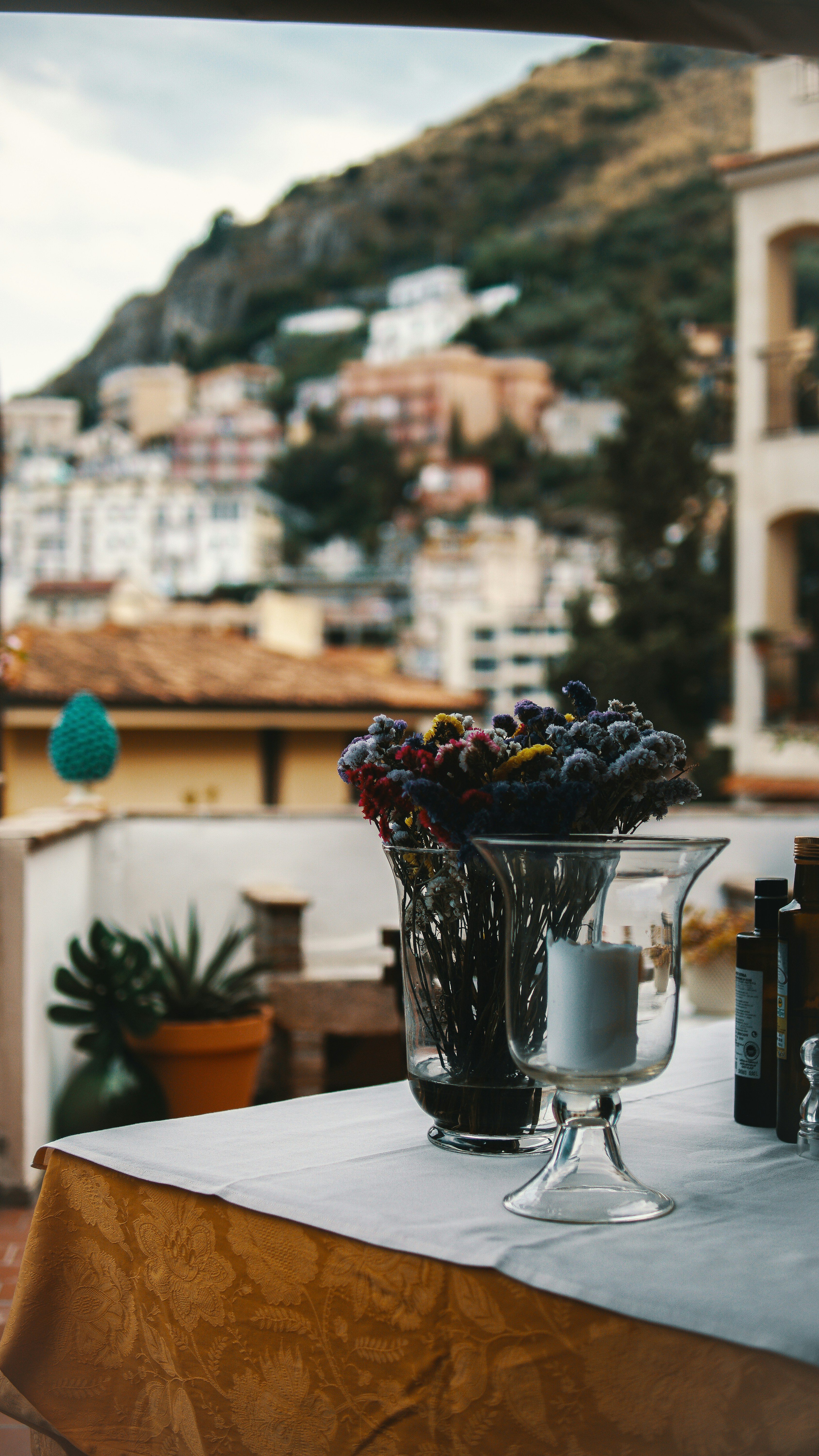 Dried Bouquet on a Sunlit Terrace Over a Blurred Cityscape