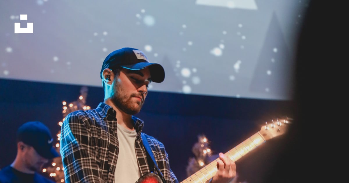 Man In Blue And White Plaid Dress Shirt Playing Guitar Photo Free