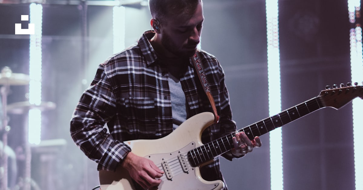 Man In Black White And Blue Plaid Dress Shirt Playing Electric Guitar