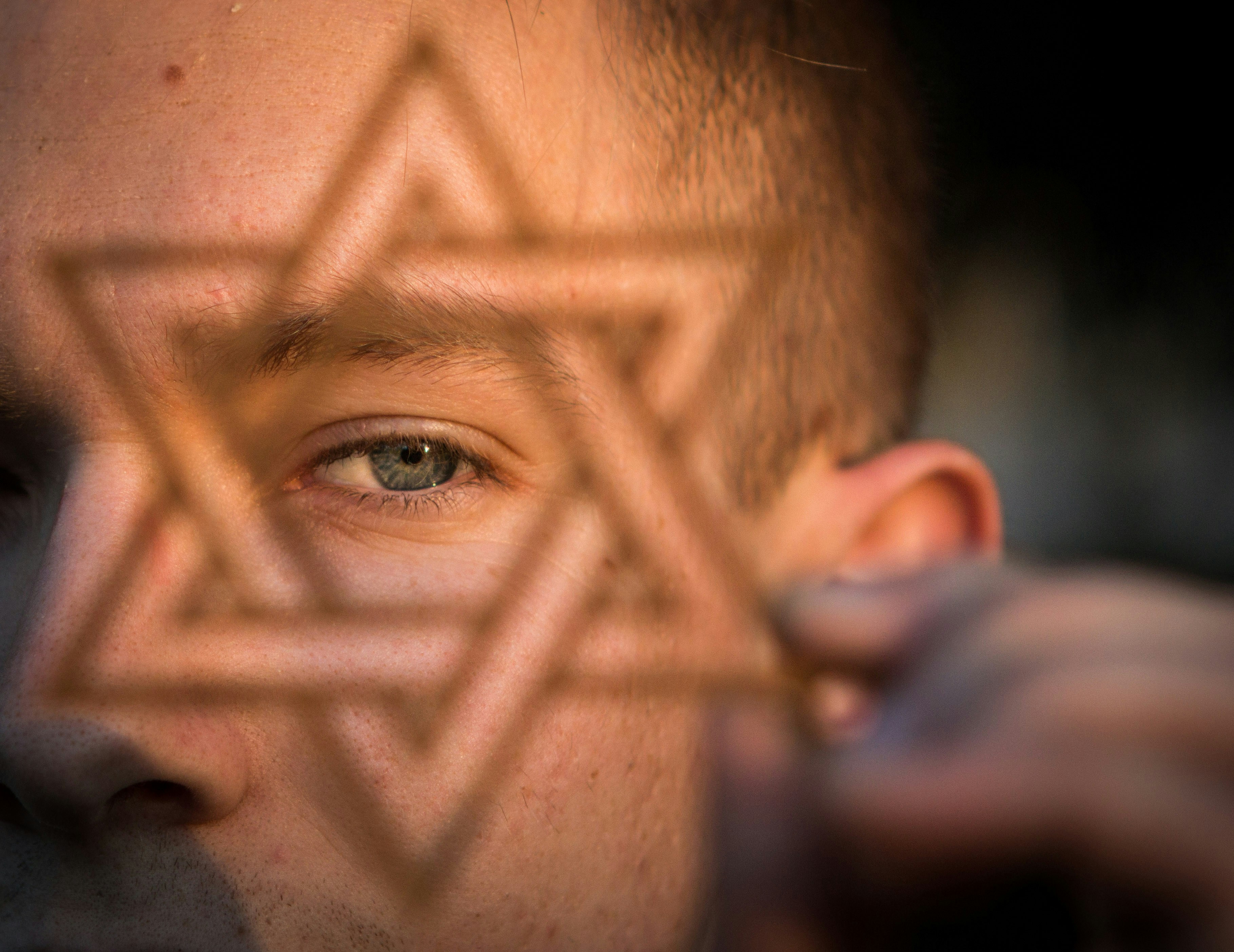 Eye Behind the Star: Portrait Framed by Geometry