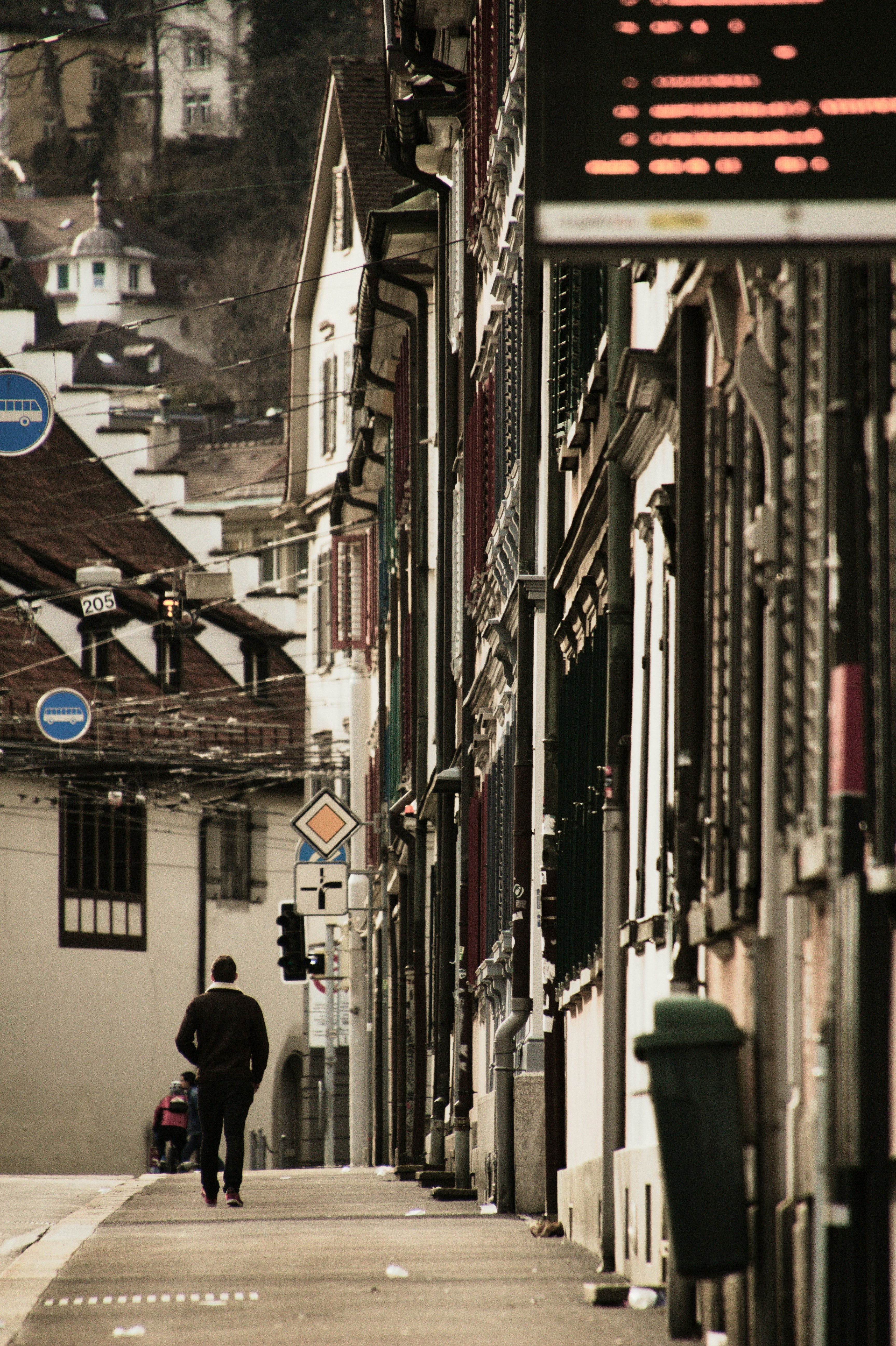 Lone Pedestrian in a Narrow European Street Canyon