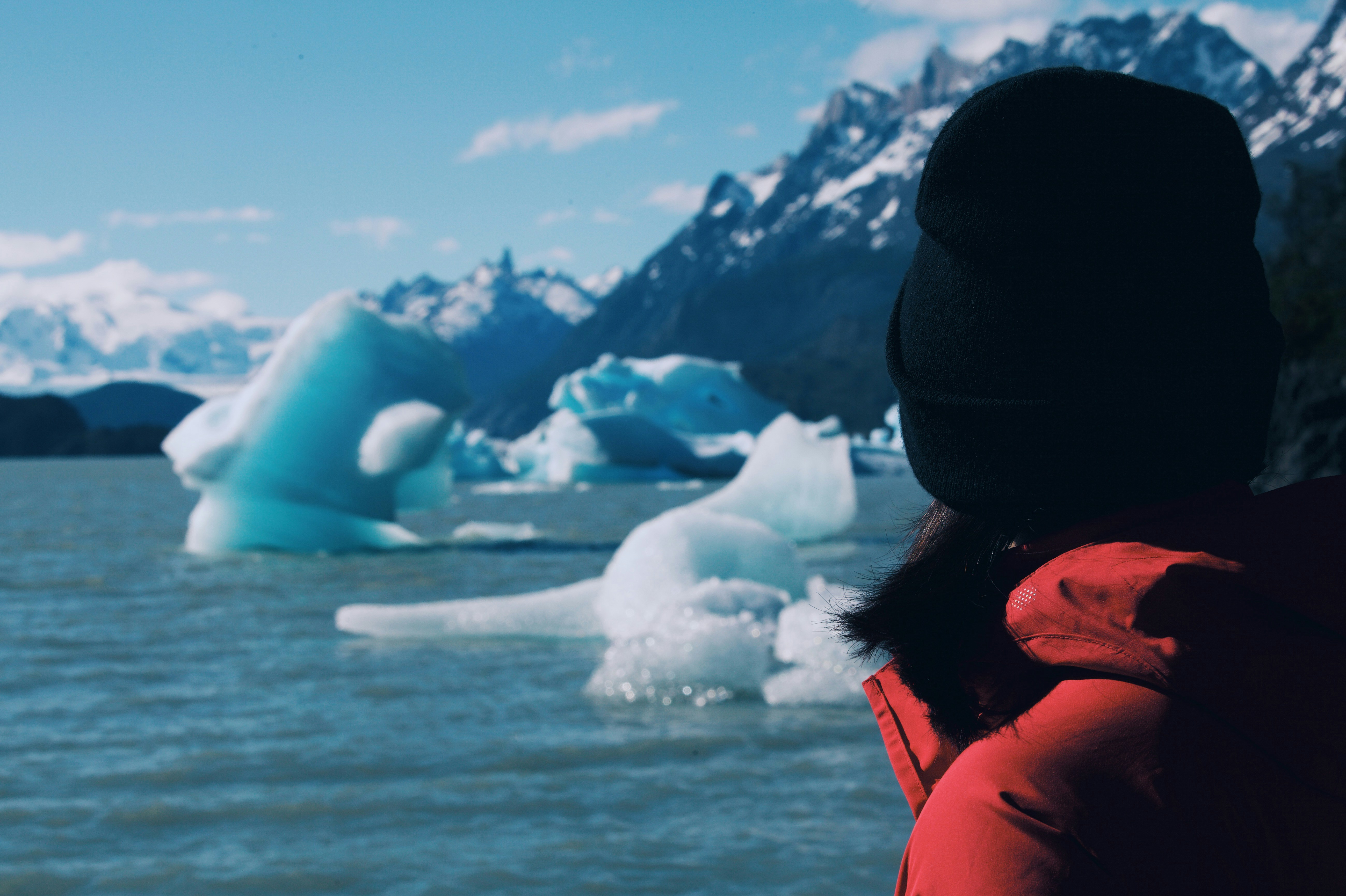 Crimson-jacketed Explorer Gazes Toward Icebound Fjords