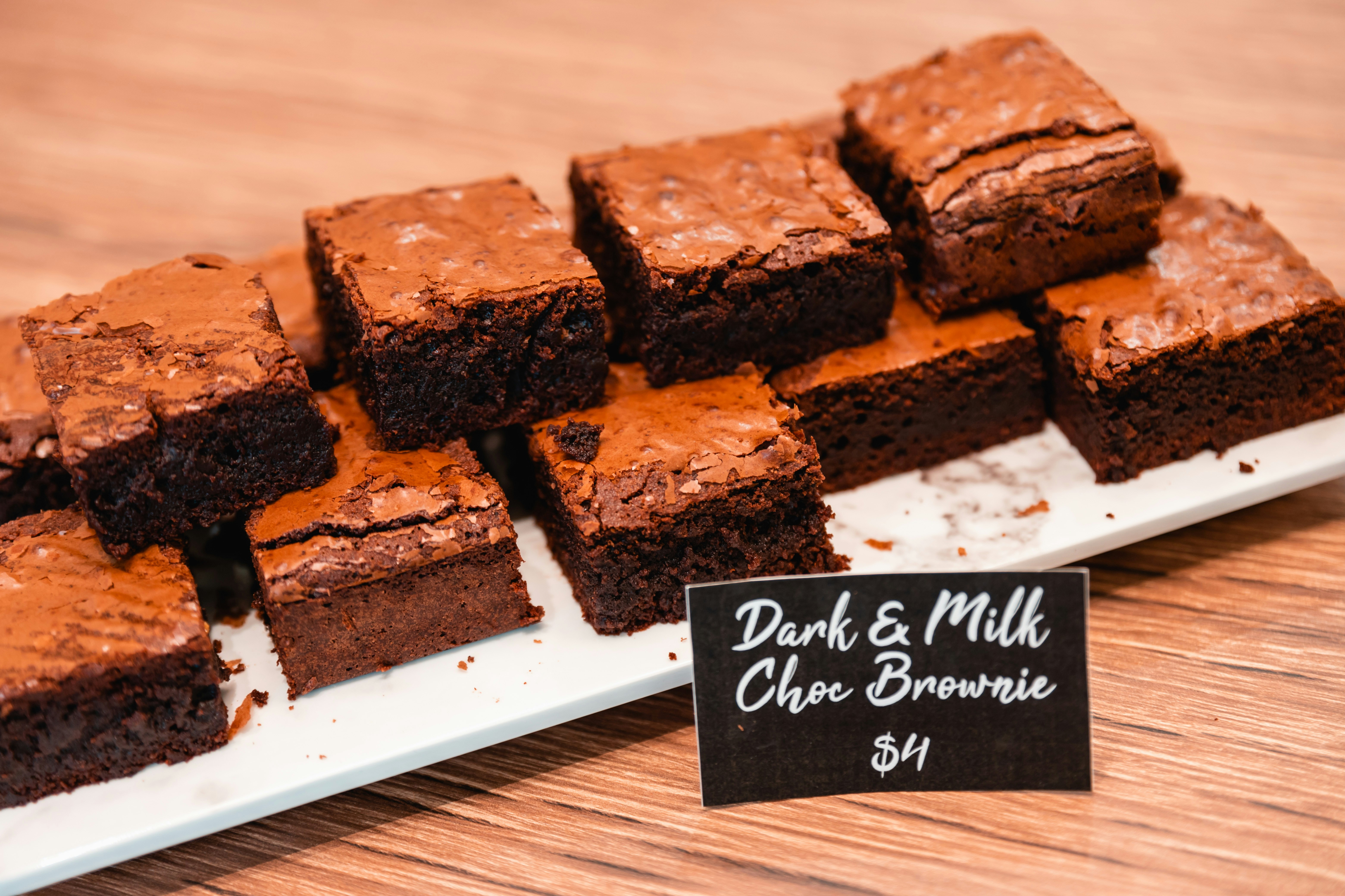 Glossy Cocoa Blocks Line Up: Dark and Milk Chocolate Brownies on a Rustic Plate