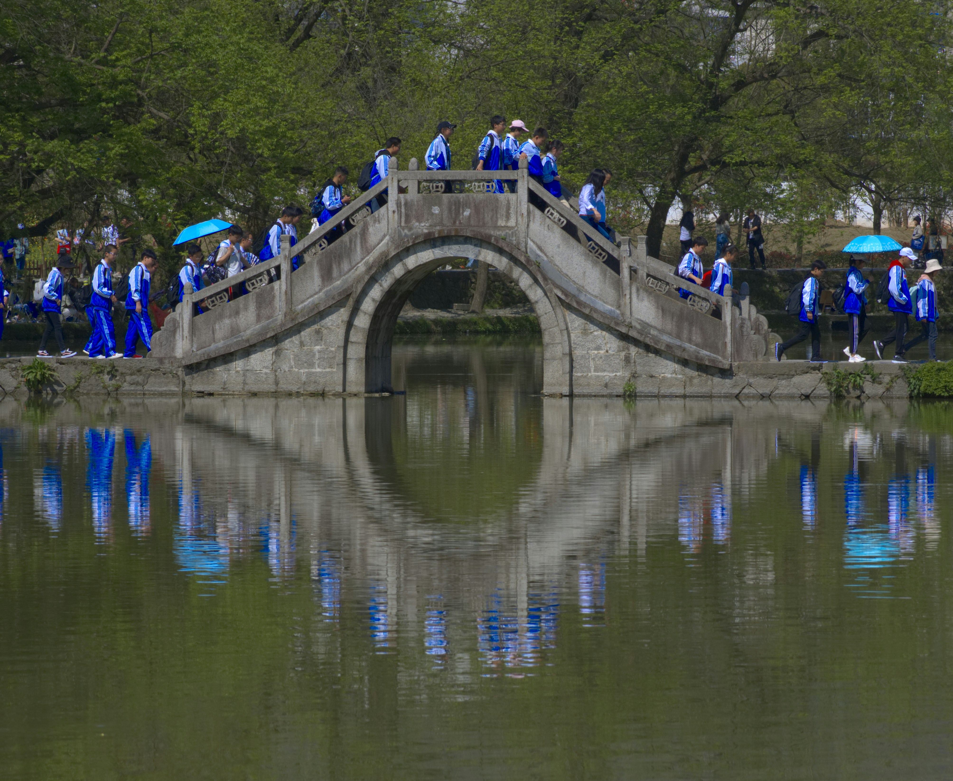 People walking on bridge over river during daytime photo – Free Grey ...