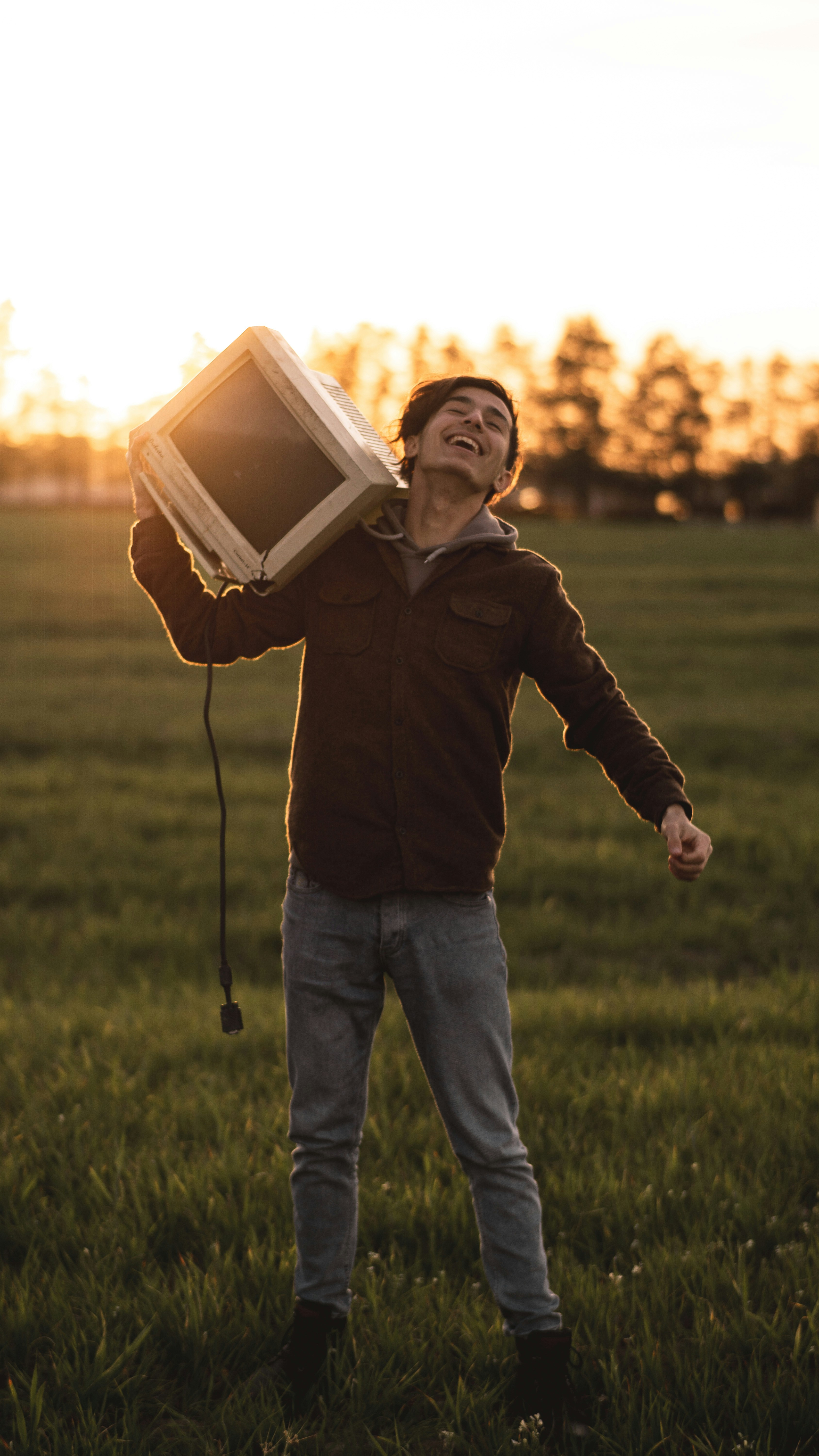 Field of Light: Man Wrangles a Vintage Monitor Under Sunset