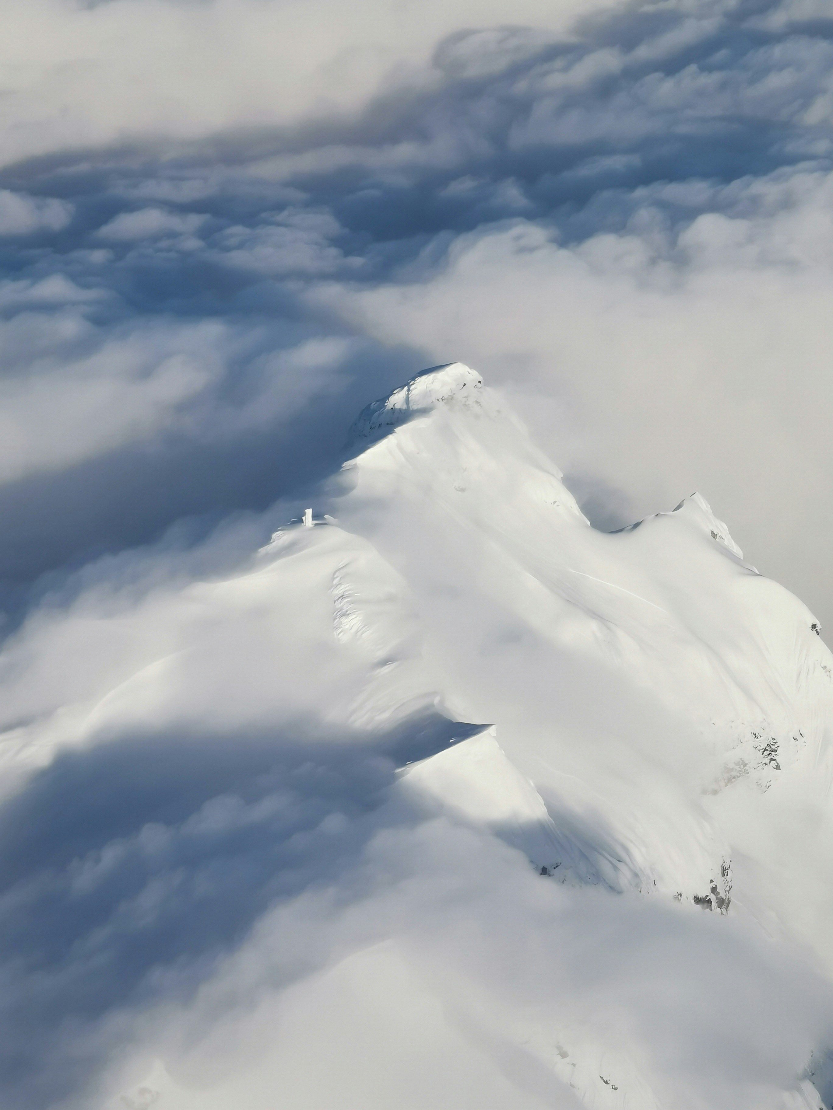 Ivory Summit Pierces a Sea of Clouds
