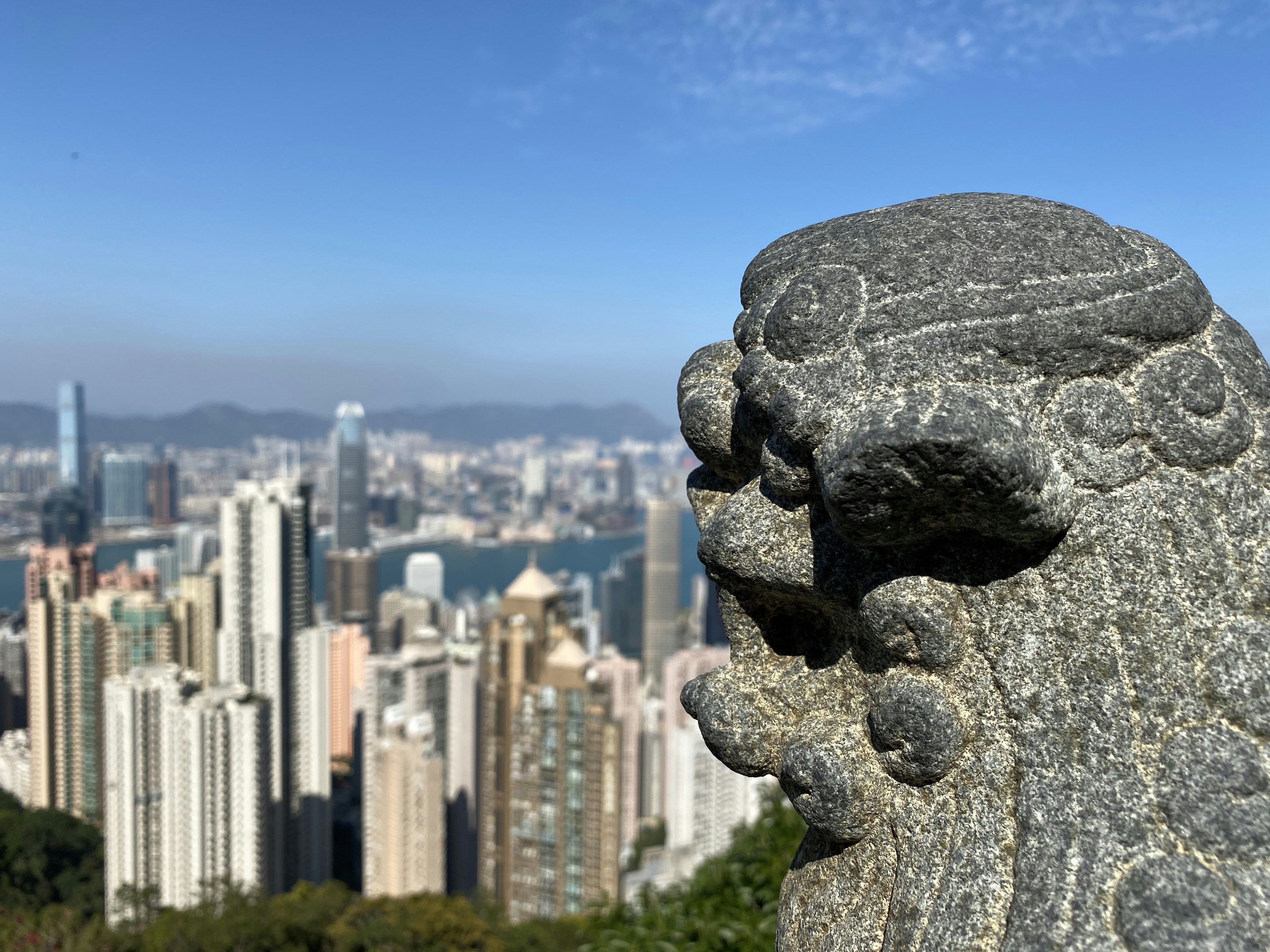 Stone guardian overlooking a radiant cityscape