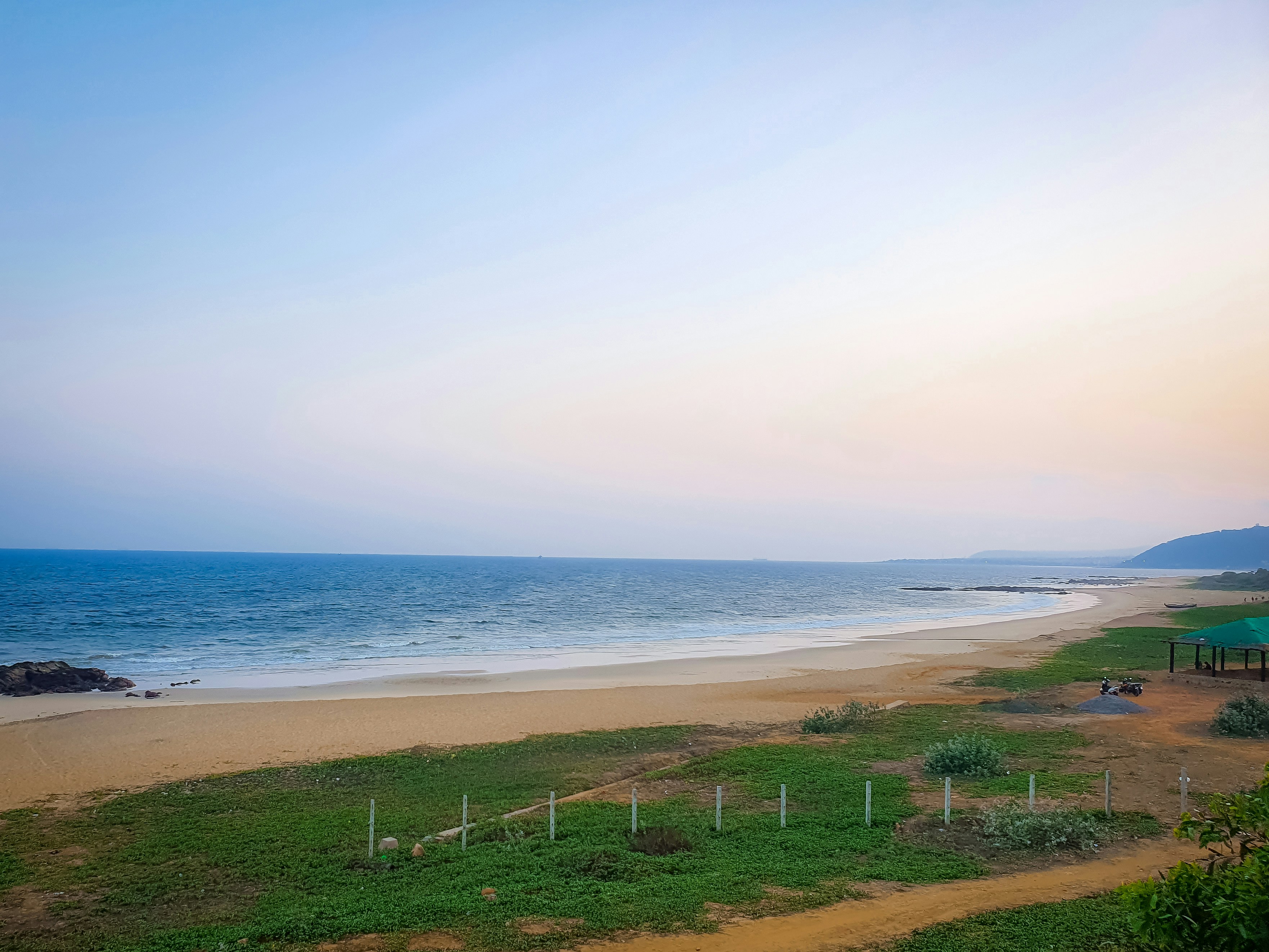 Green grass field near sea during daytime photo – Free Beach Image on ...