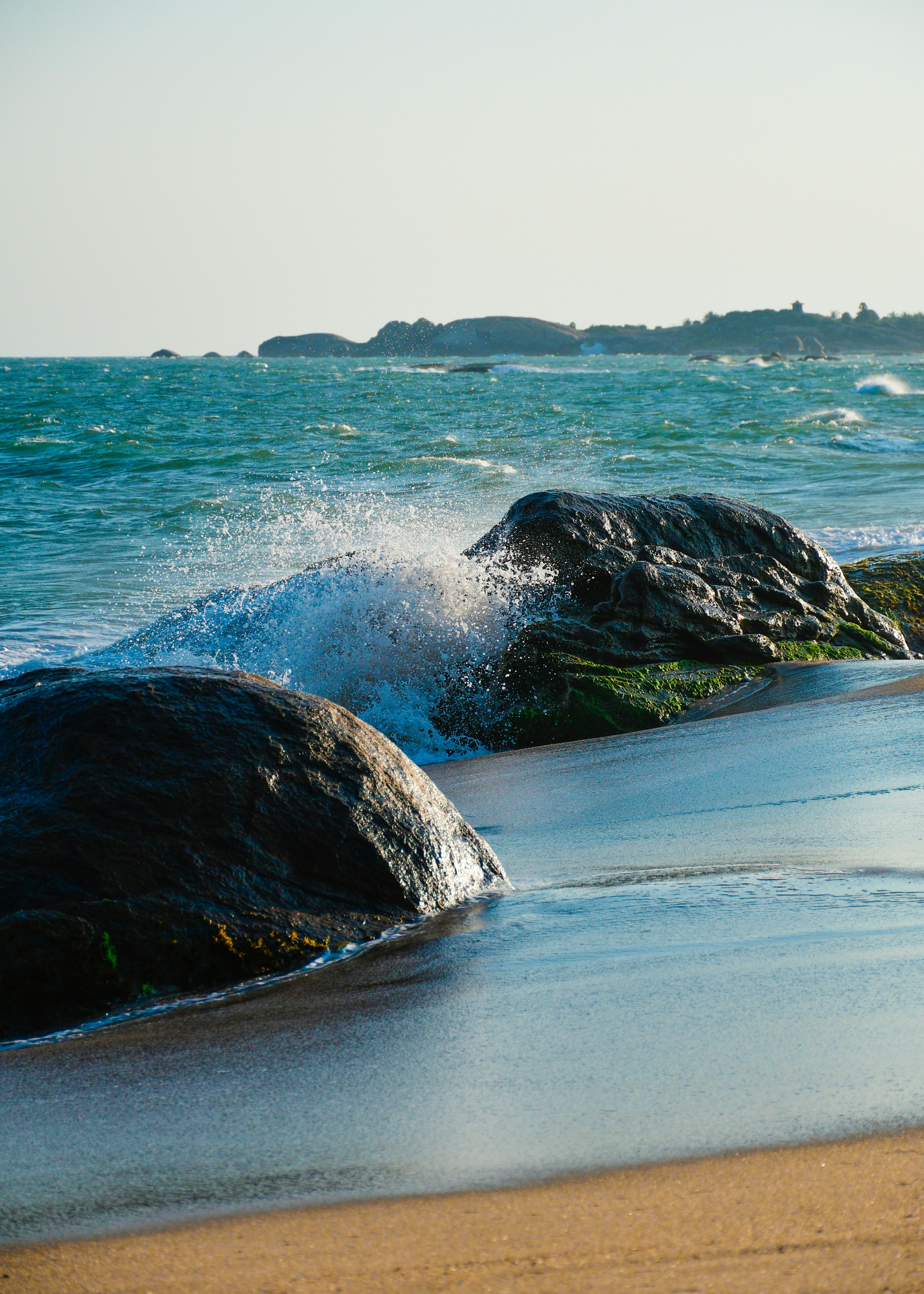 Black rock formation on sea water during daytime photo – Free Kirinda ...