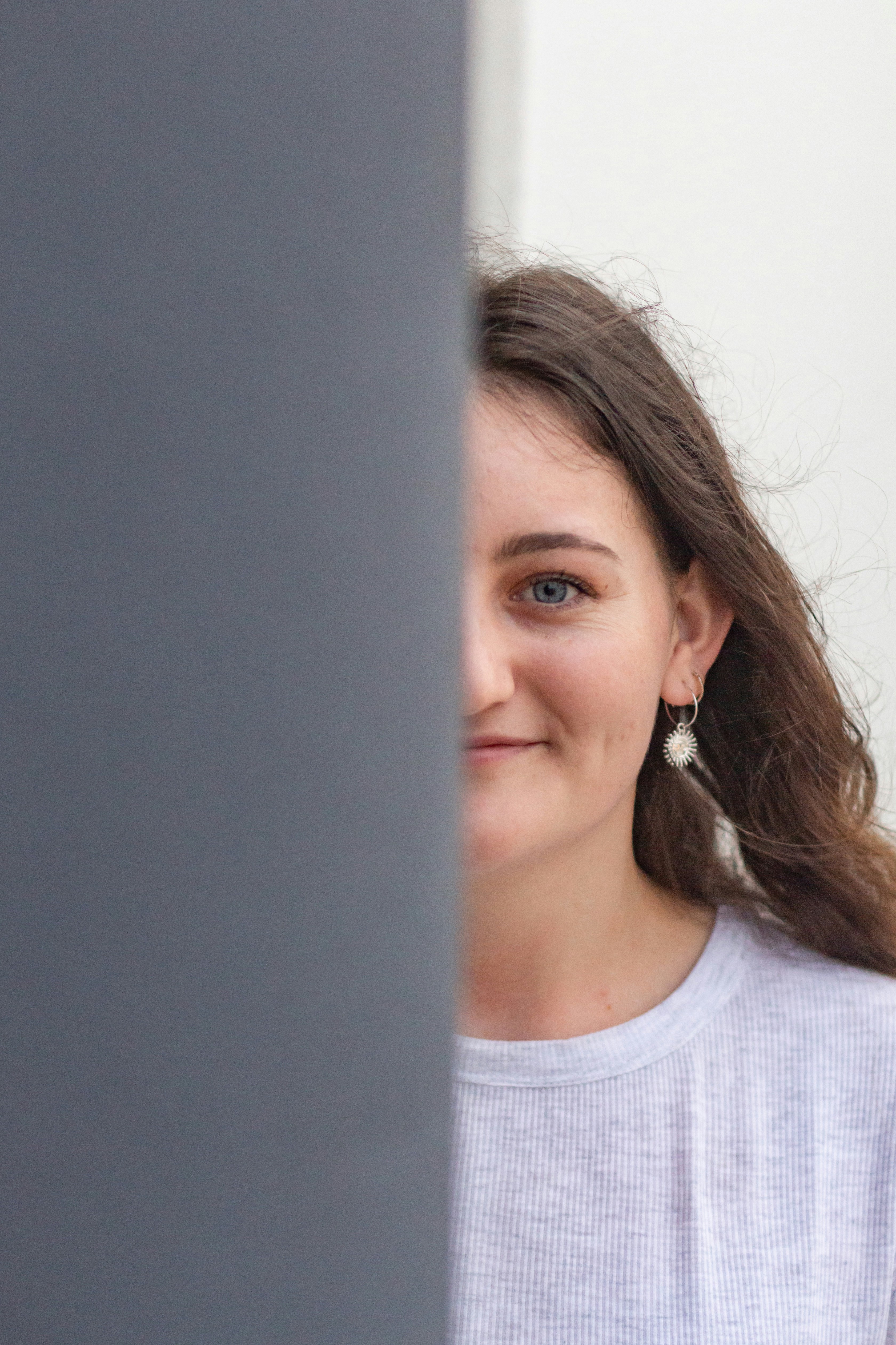 Partial Reveal: A Quiet Smile Beside a Shaded Panel