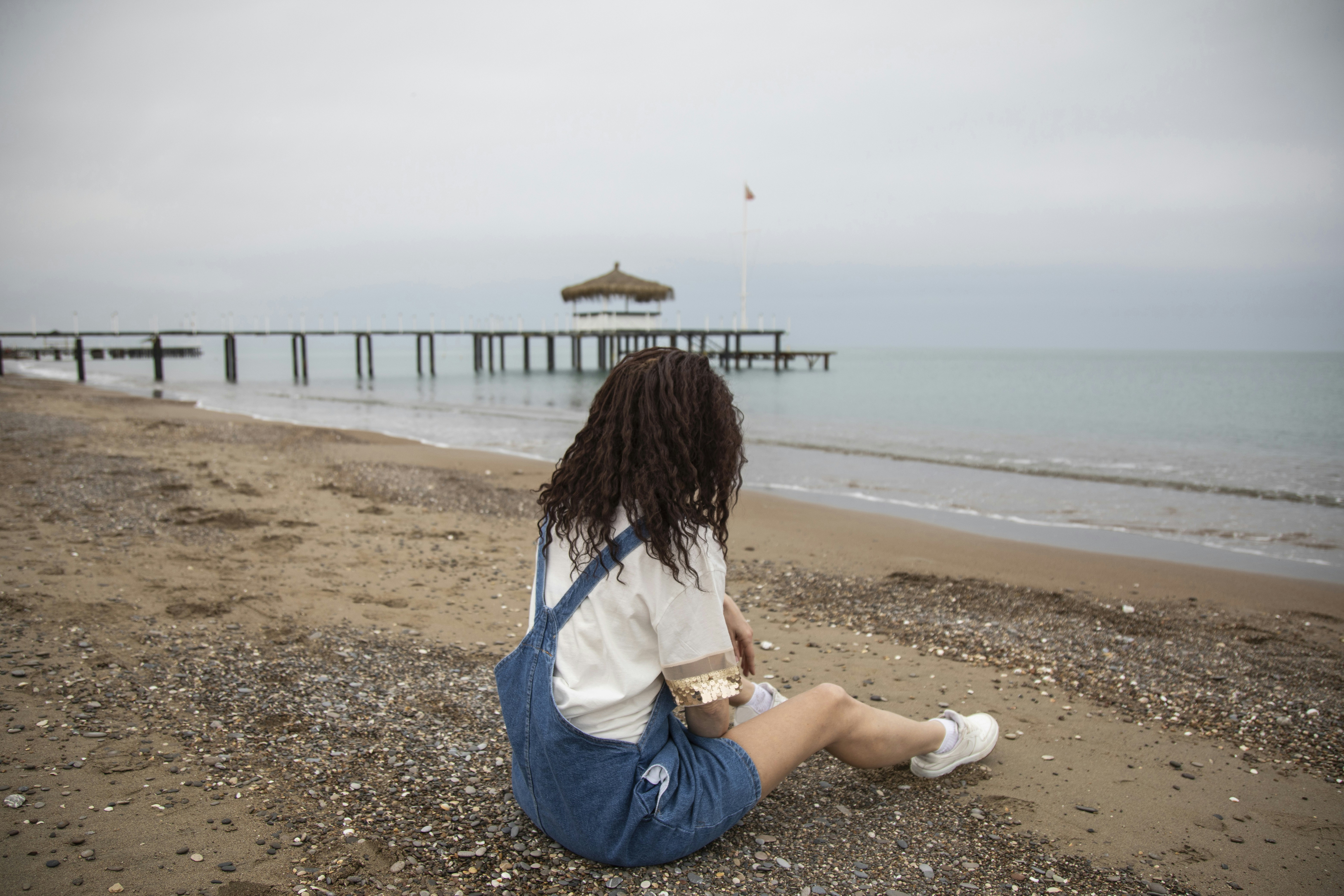 Quiet Sea Side: A Solo Moment on the Pebble Shore