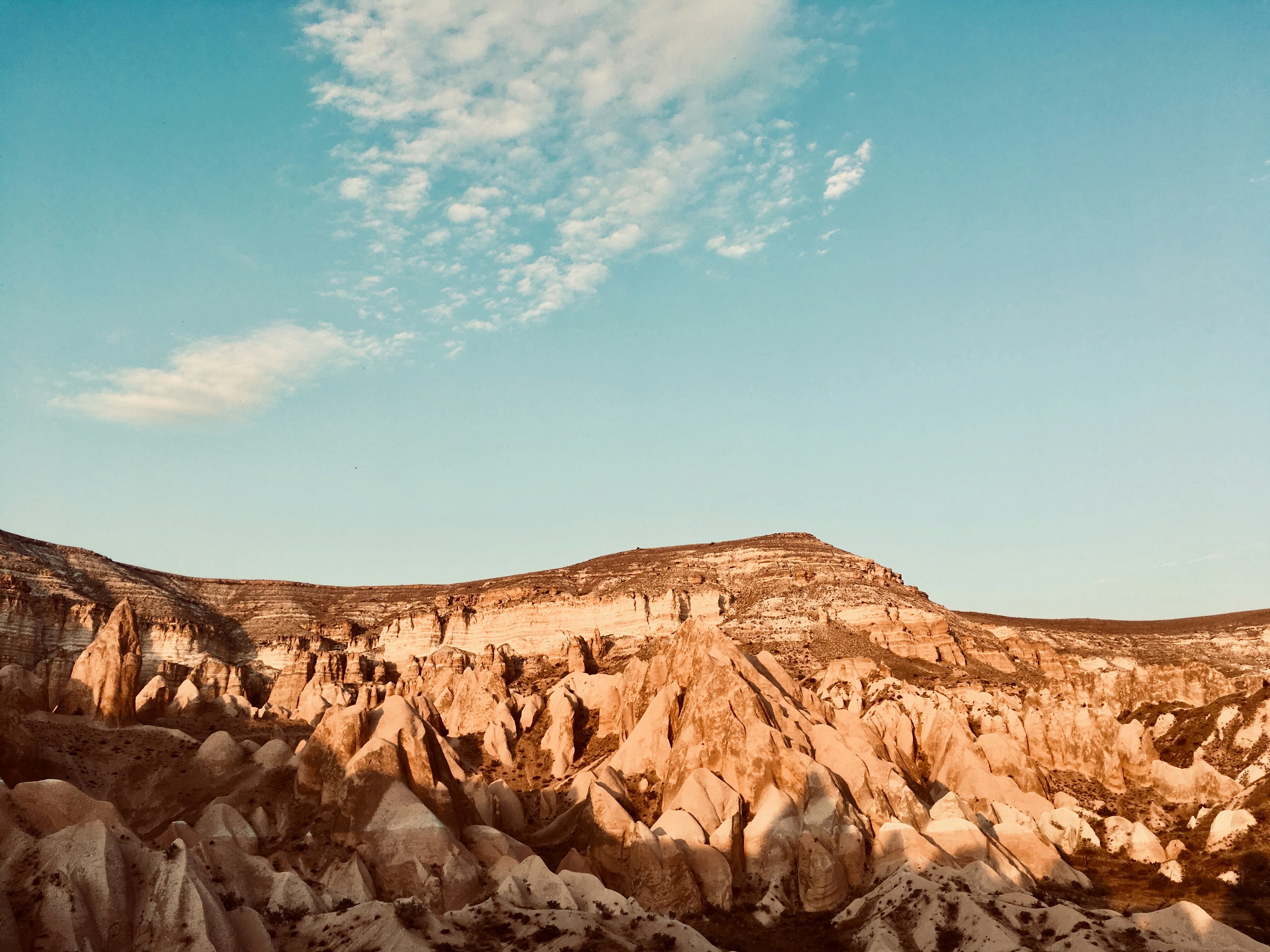 brown rock formation under blue sky during daytime