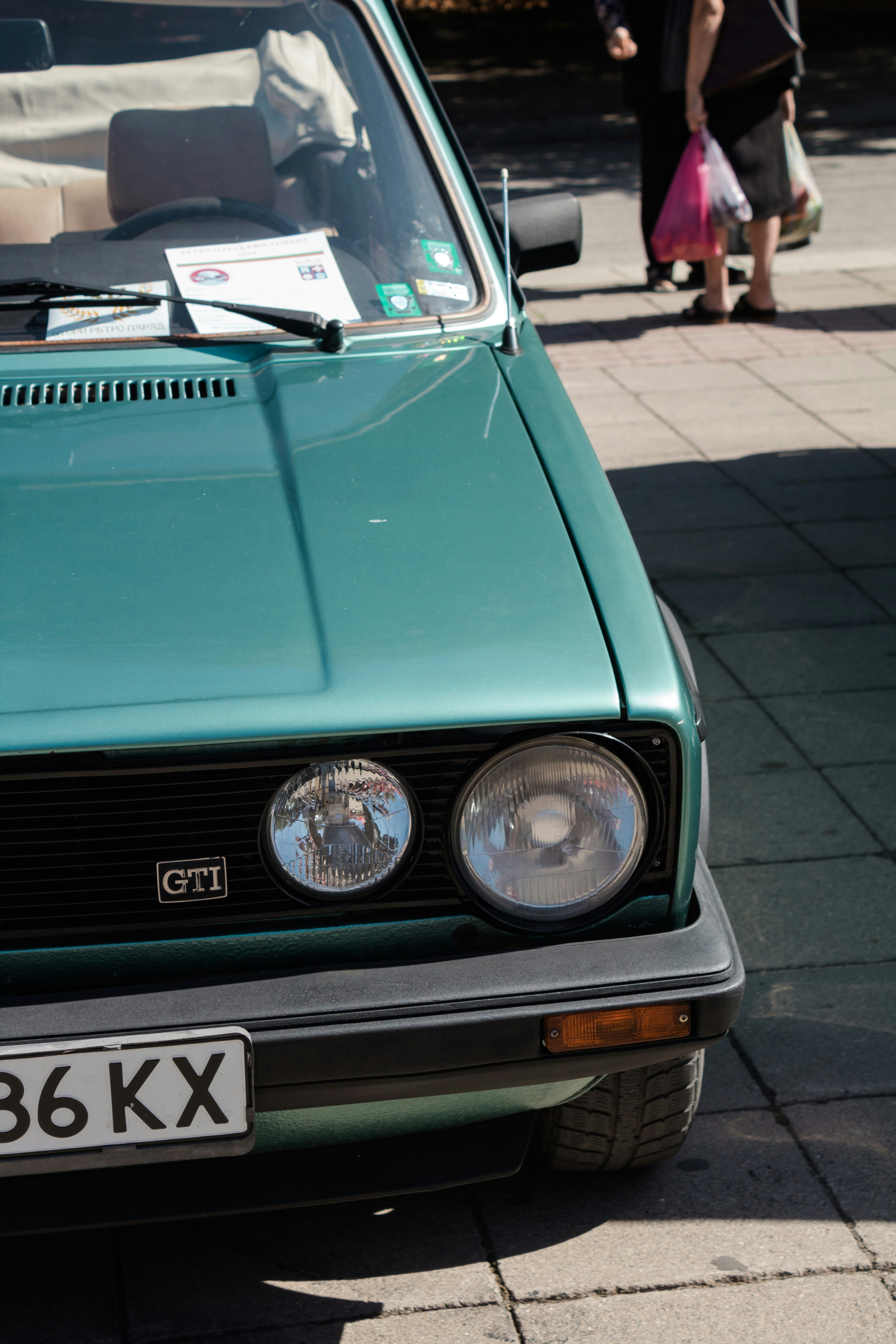 teal car on gray concrete floor