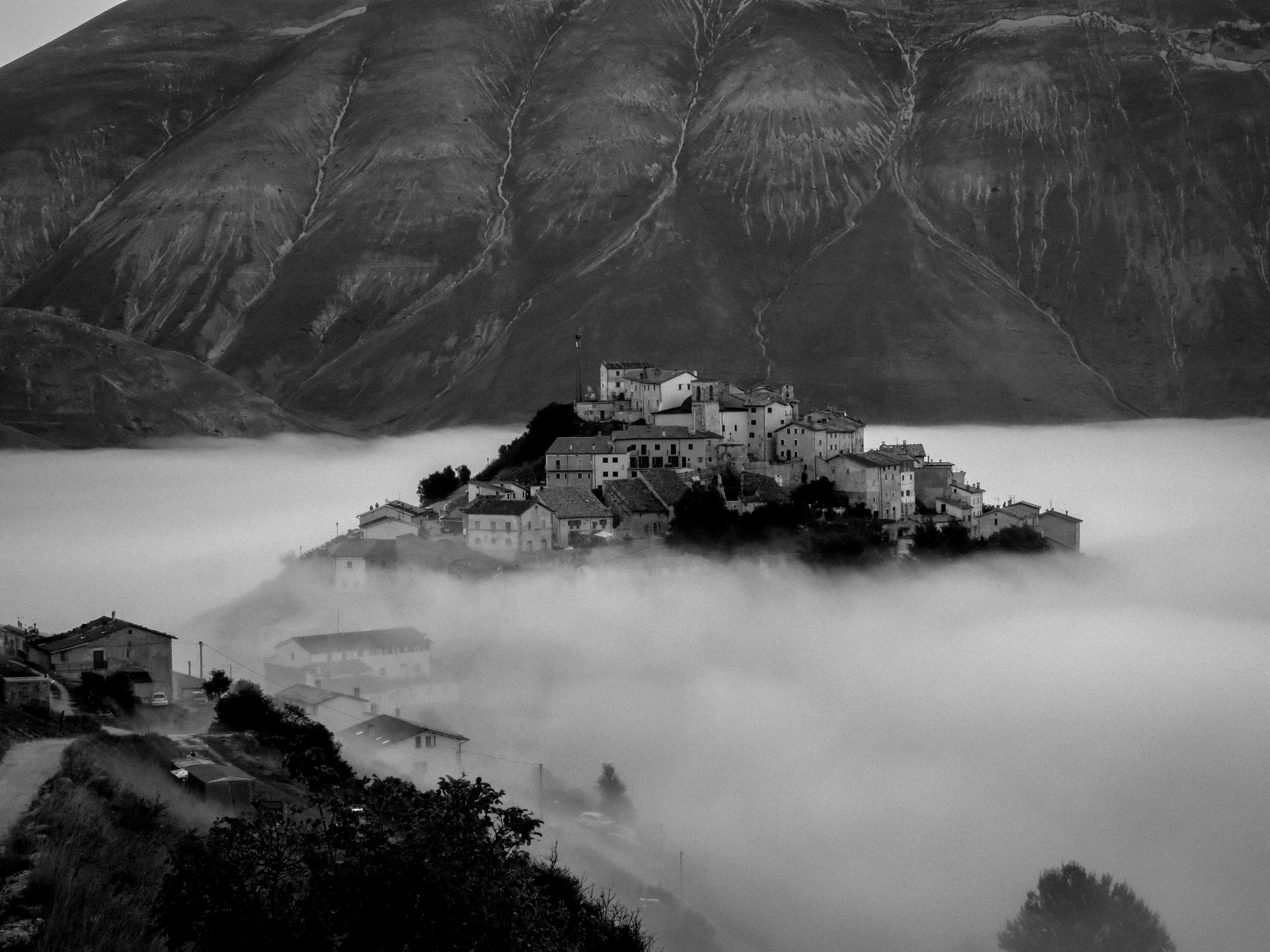 Hilltop in the Mist: A Stone Village Rising from Alpine Fog