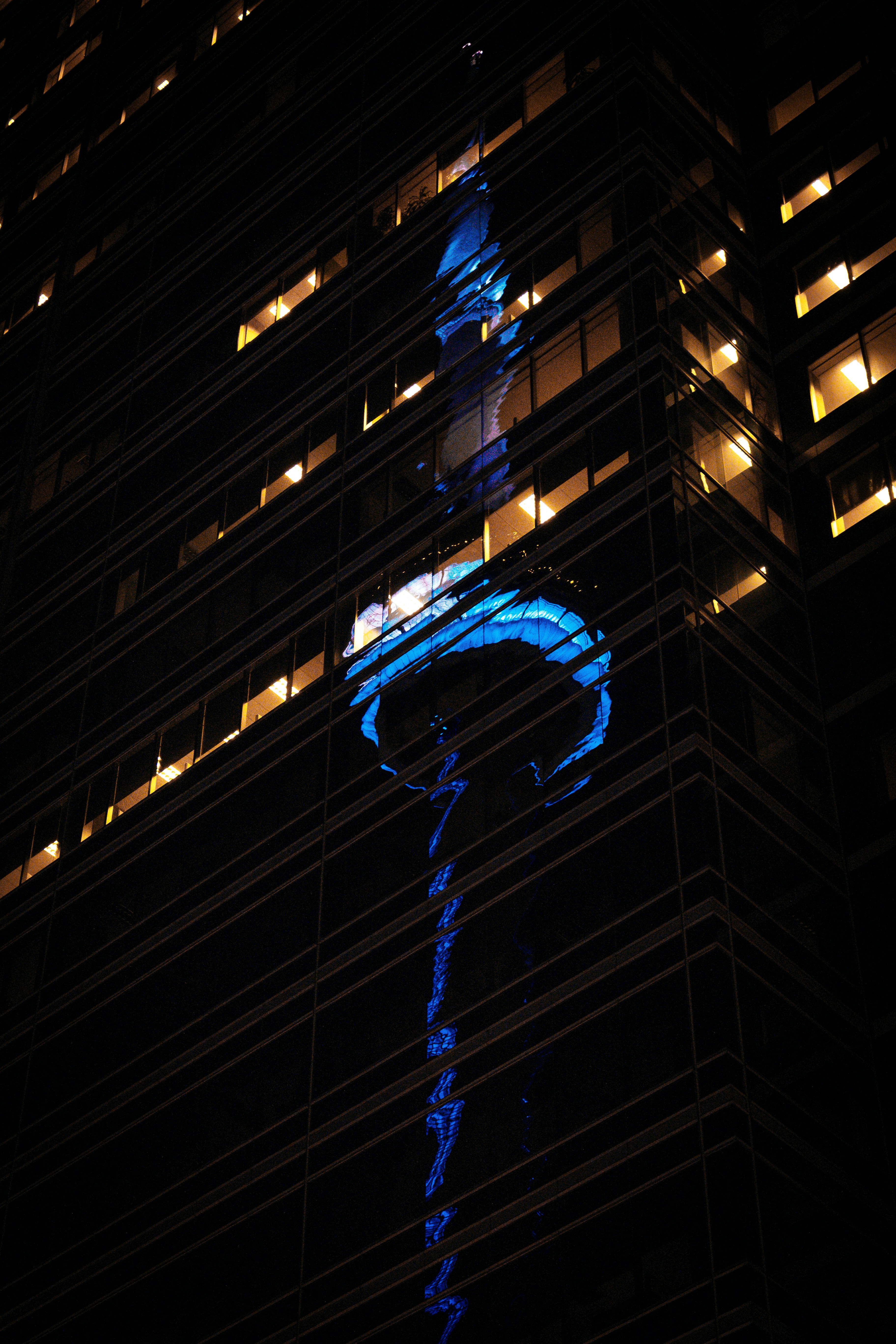 Blue Neon Ring on a Glass-Clad Skyscraper