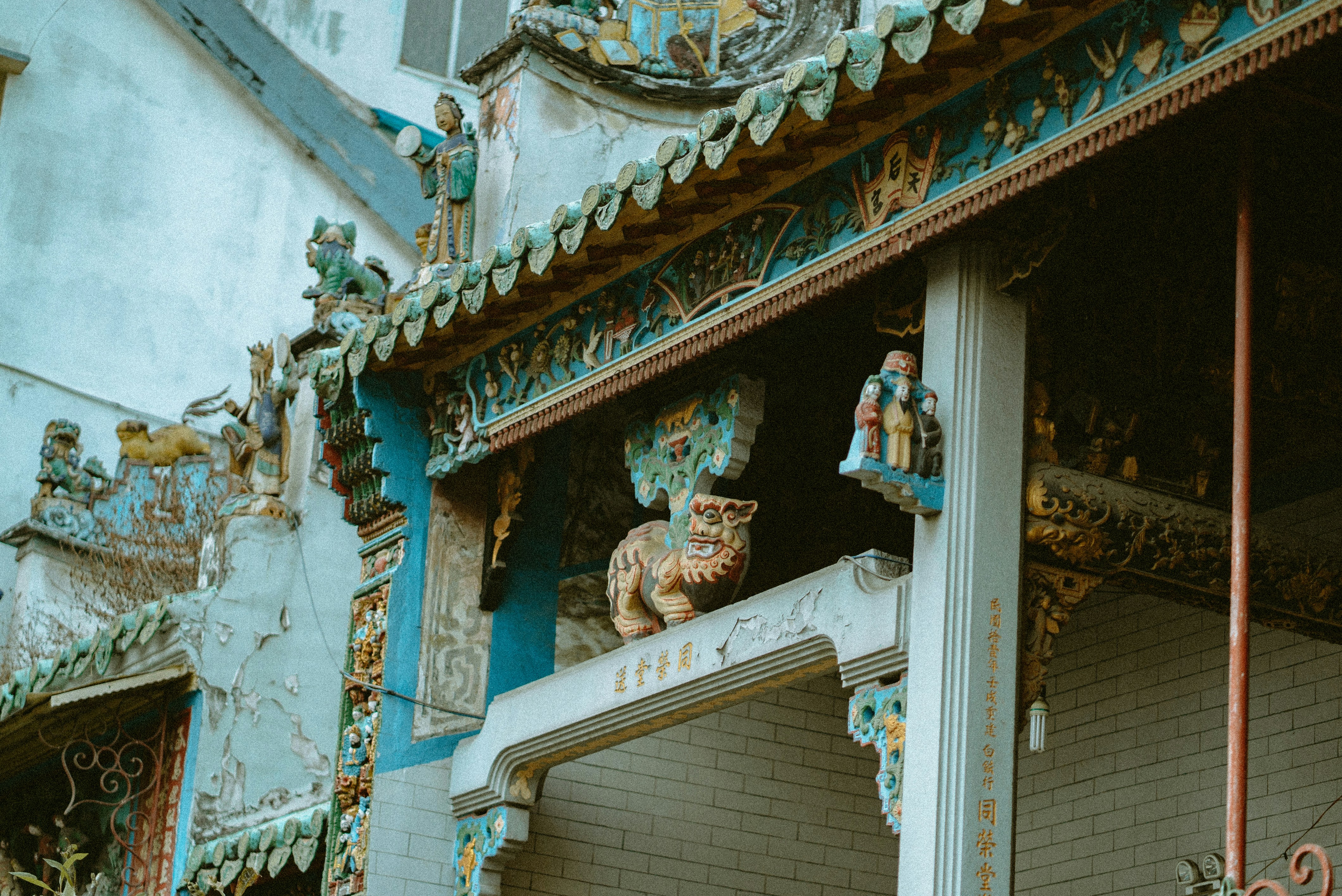 Tiger Guardian at the Threshold: Ornate Temple Façade in Teal and Stone