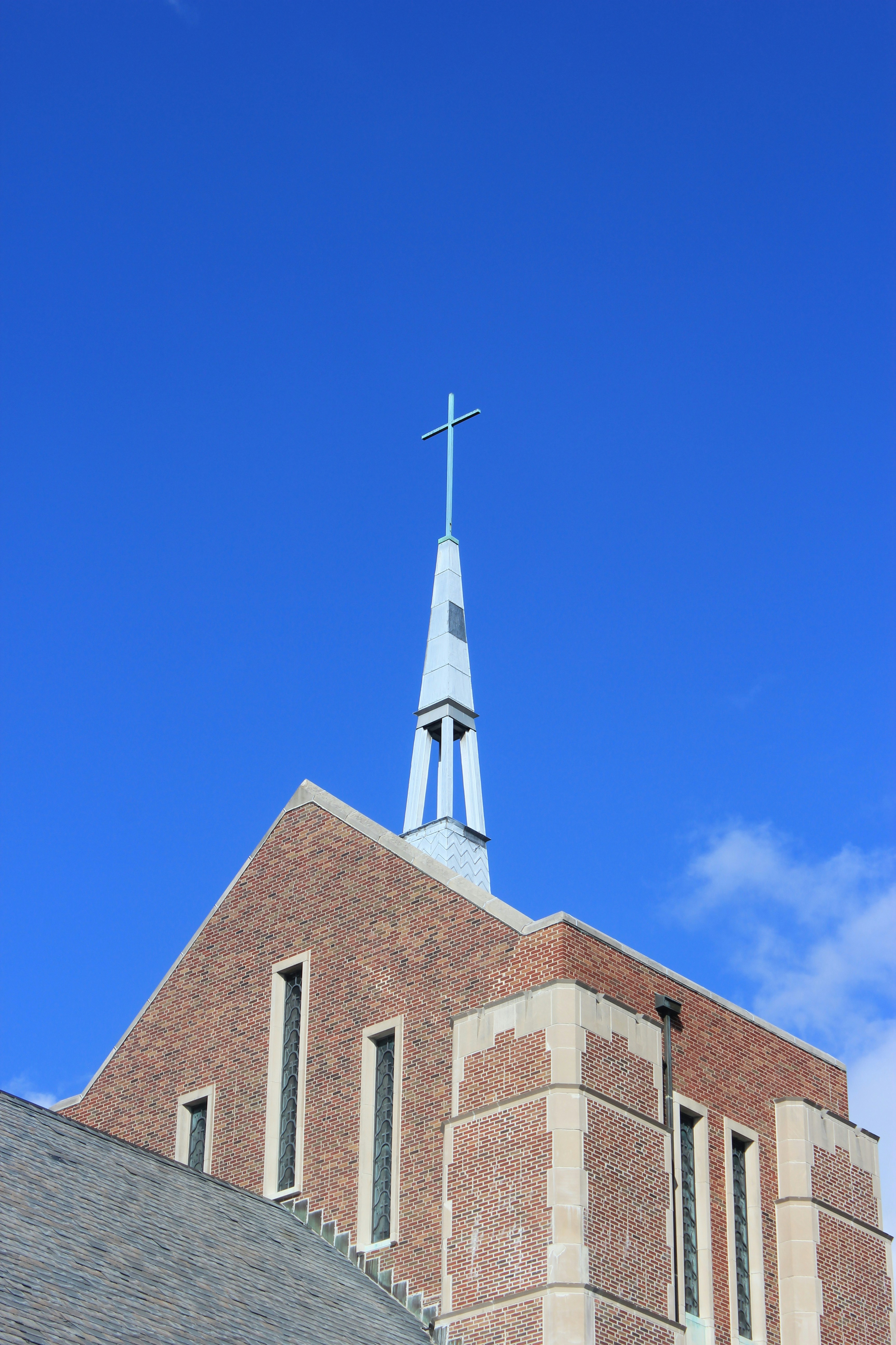 Brown and white concrete church under blue sky during daytime photo ...
