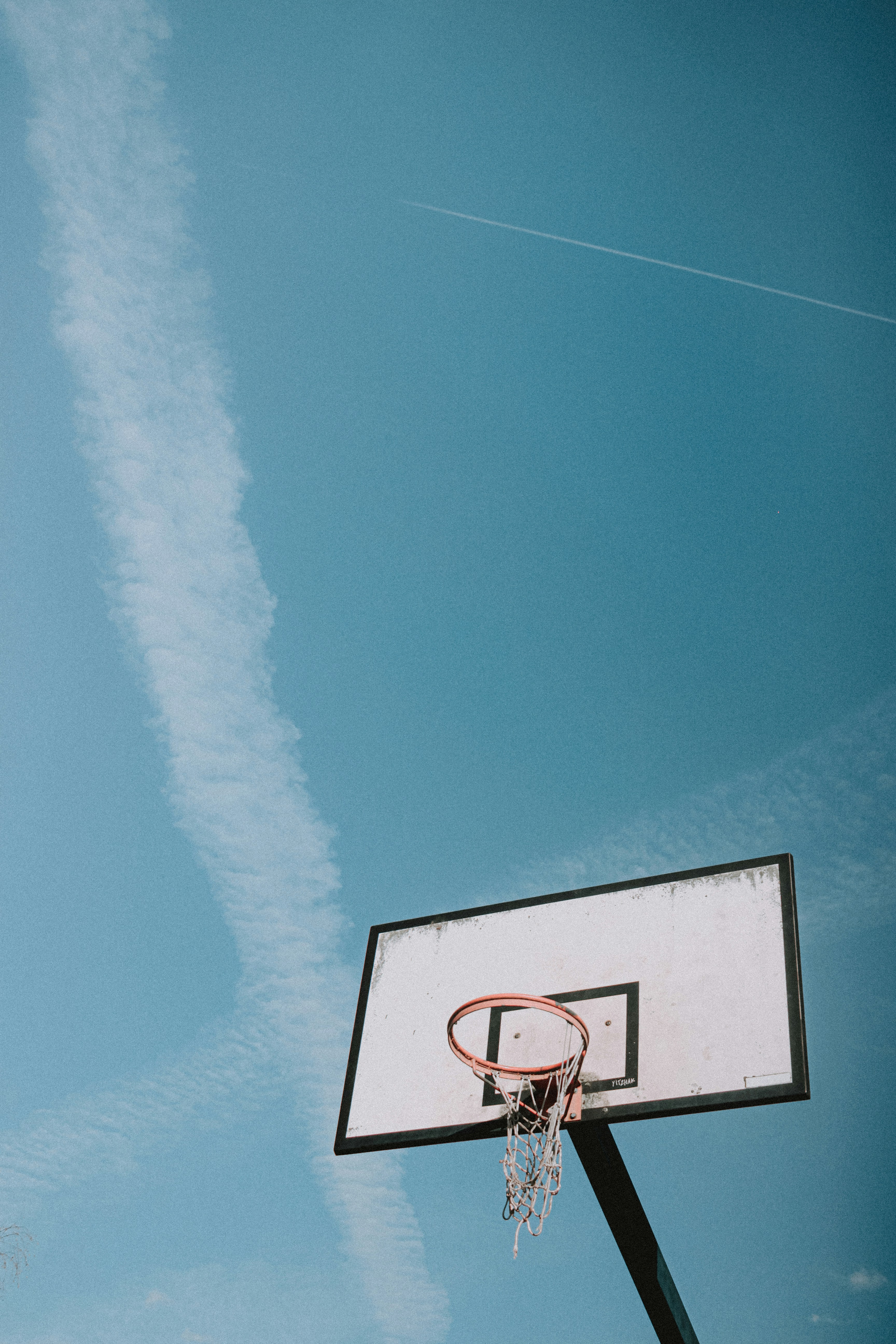 Rim Geometry Against a Cerulean Sky with Contrails