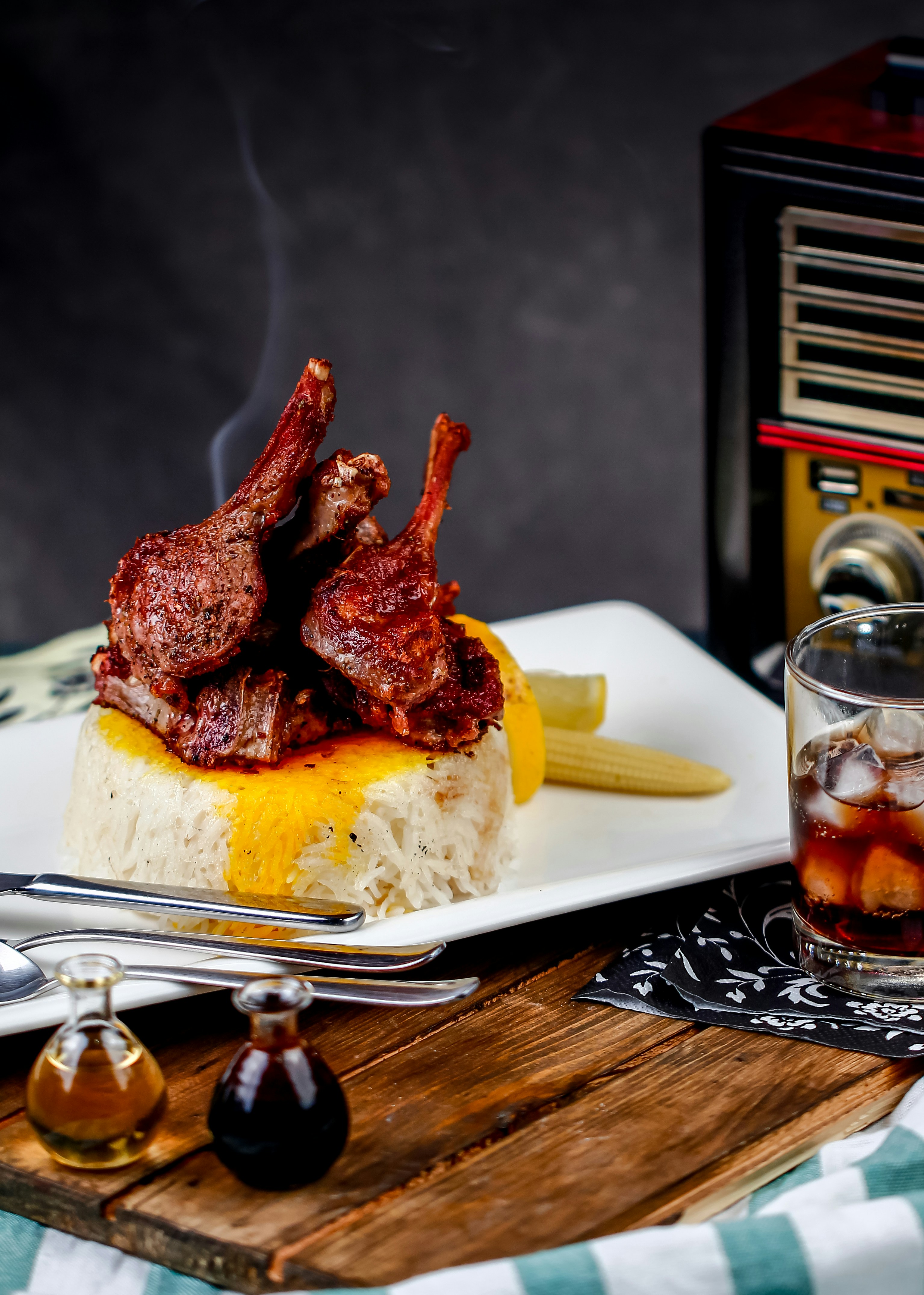Smoked Lamb atop a Citrus Crown: A Rustic Platter with Vintage Radio Glow
