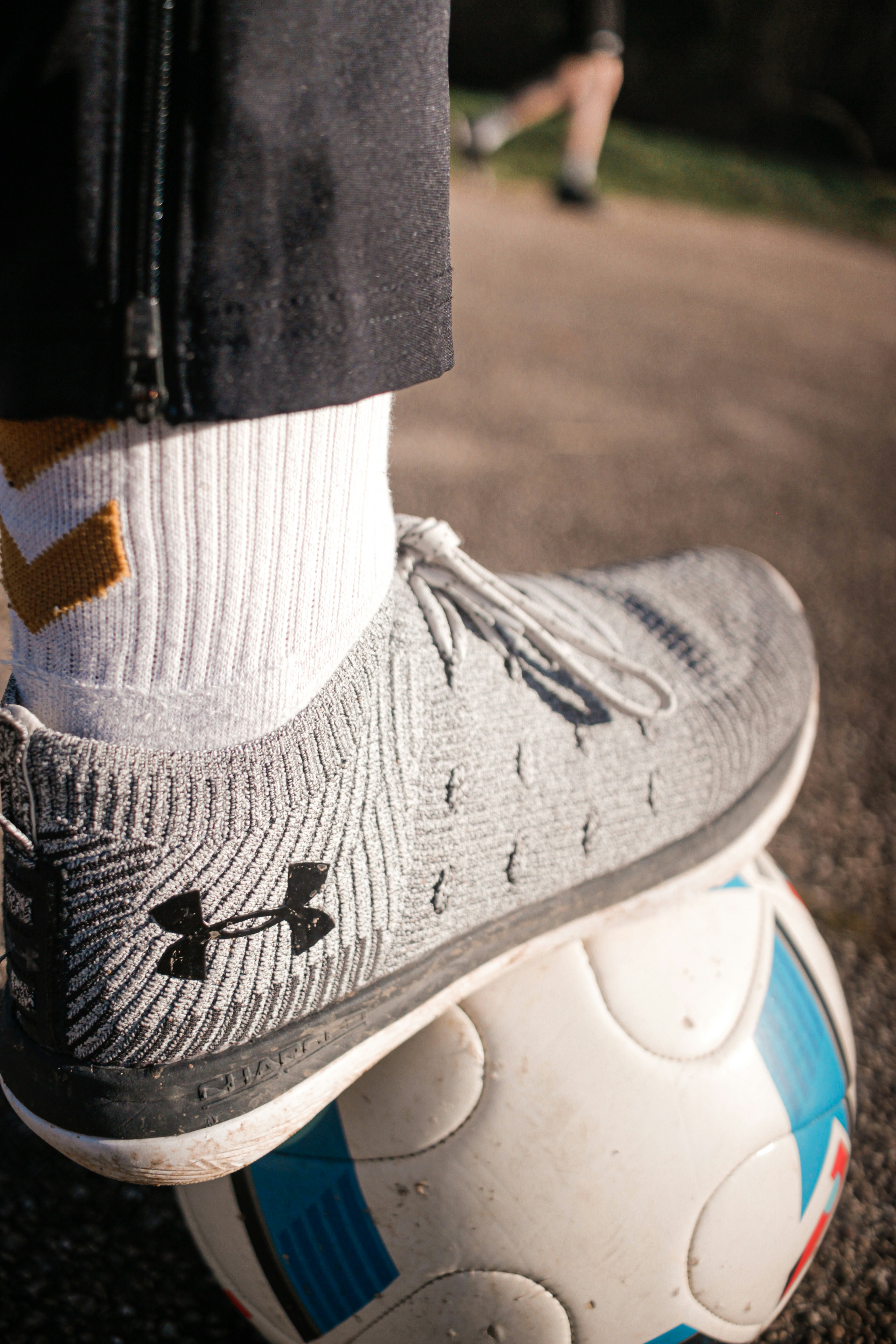 Grounded Play: A Trainer's Foot on a Soccer Ball