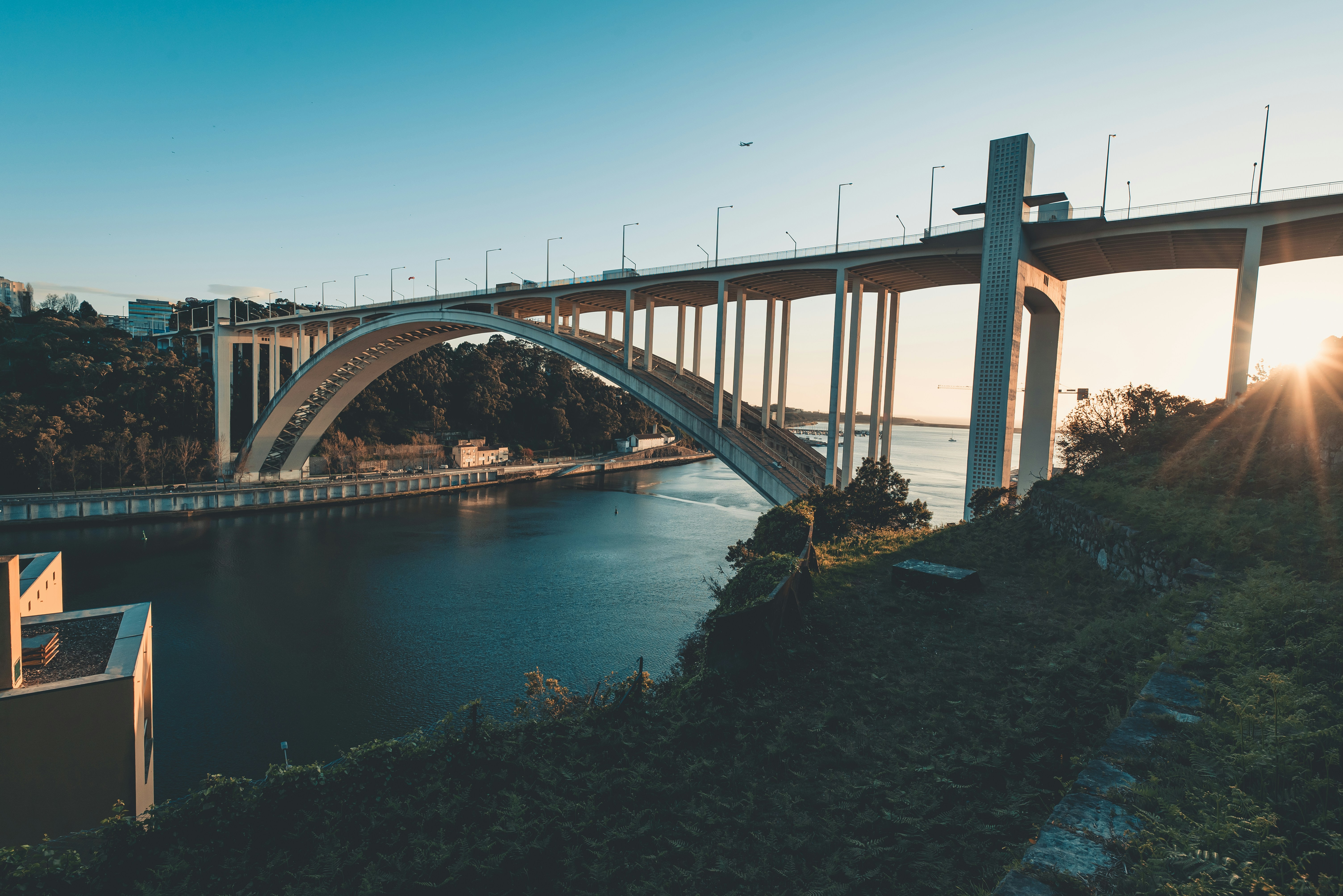 Sunlit Span Over the Quiet River: Evening Light on a Curved Bridge