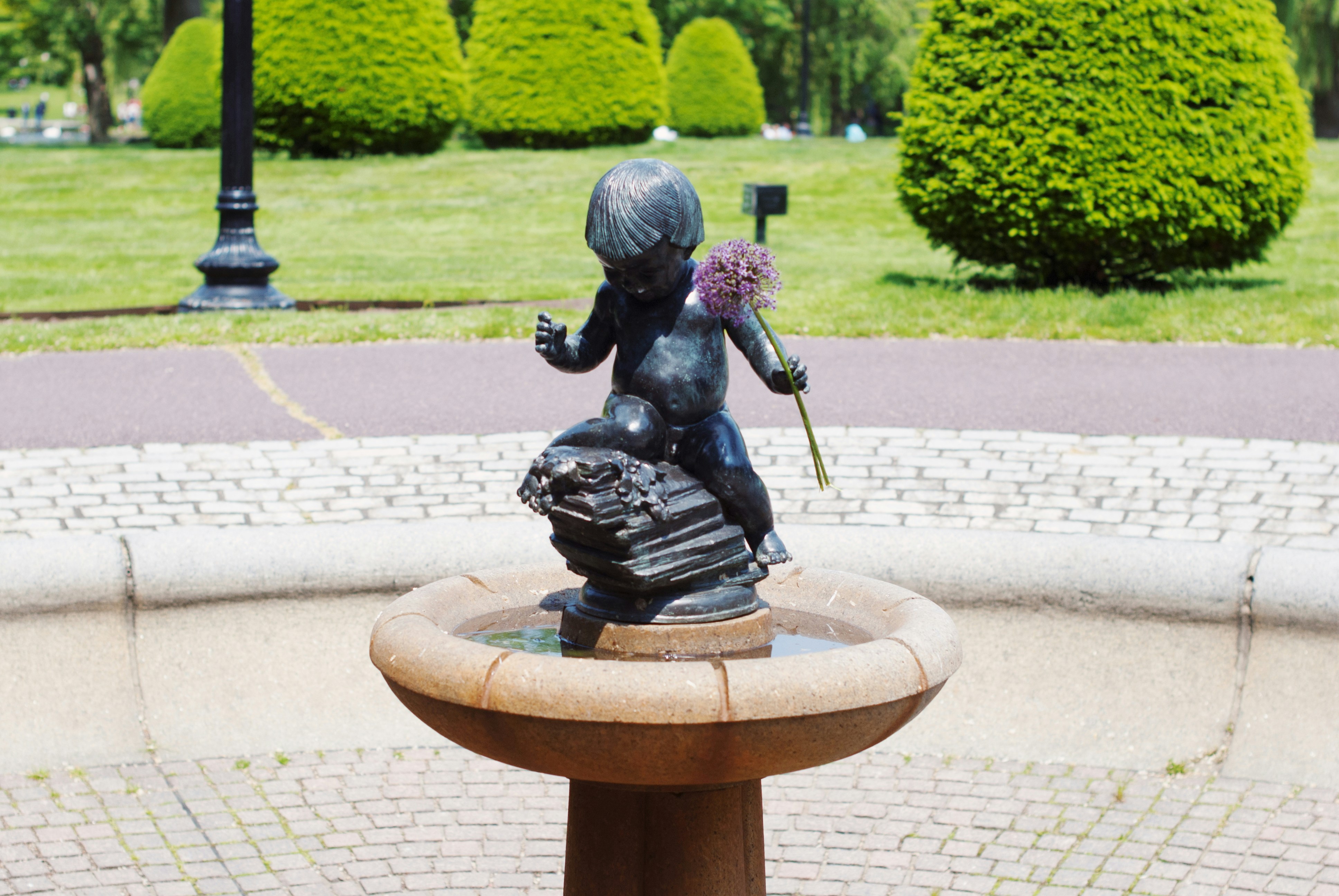 Tiny Statue, Grand Splash: A Childlike Fountain Moment