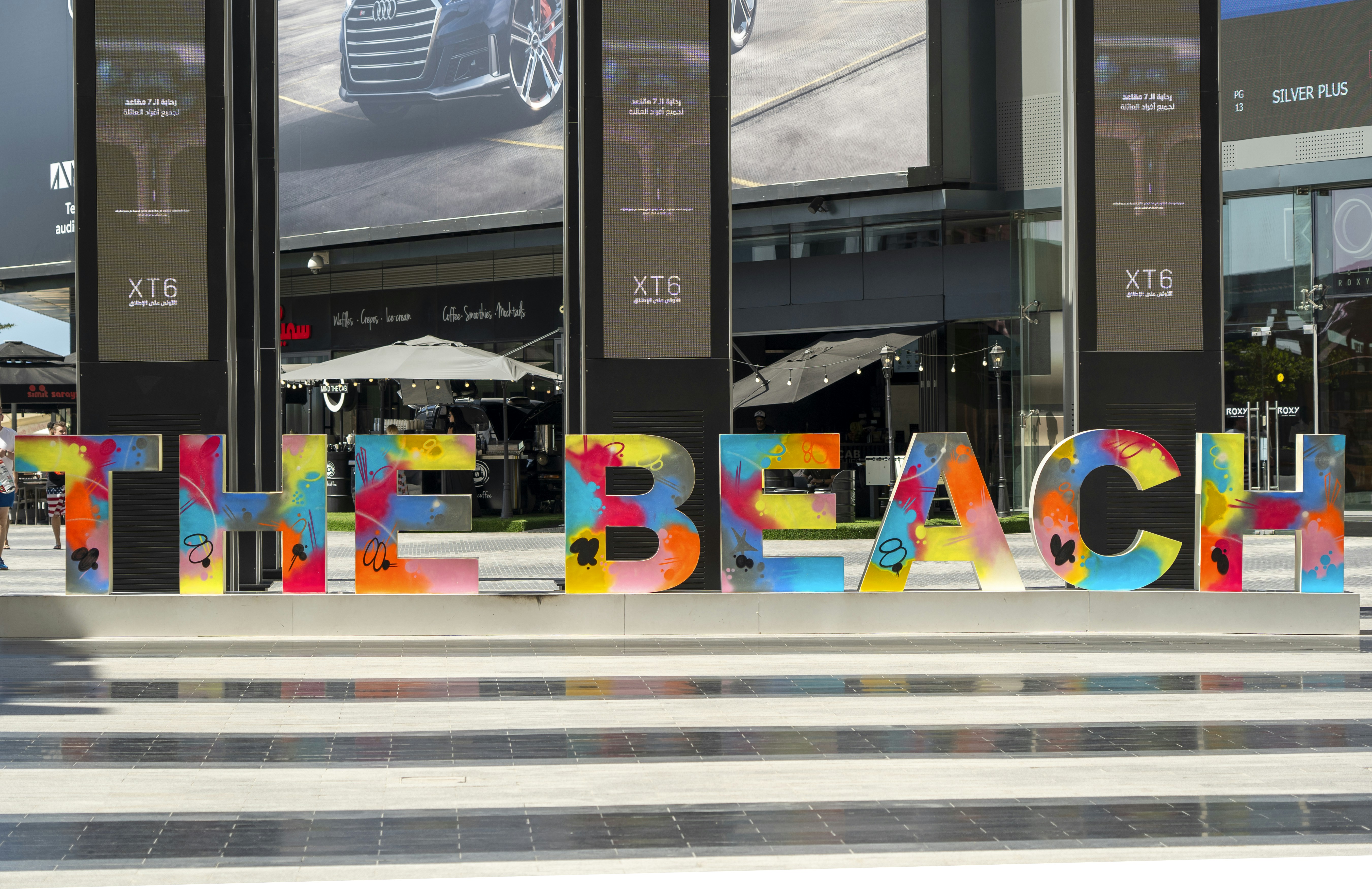 Colorful BEACH Letters Stand Tall in Front of Modern Mall Facade