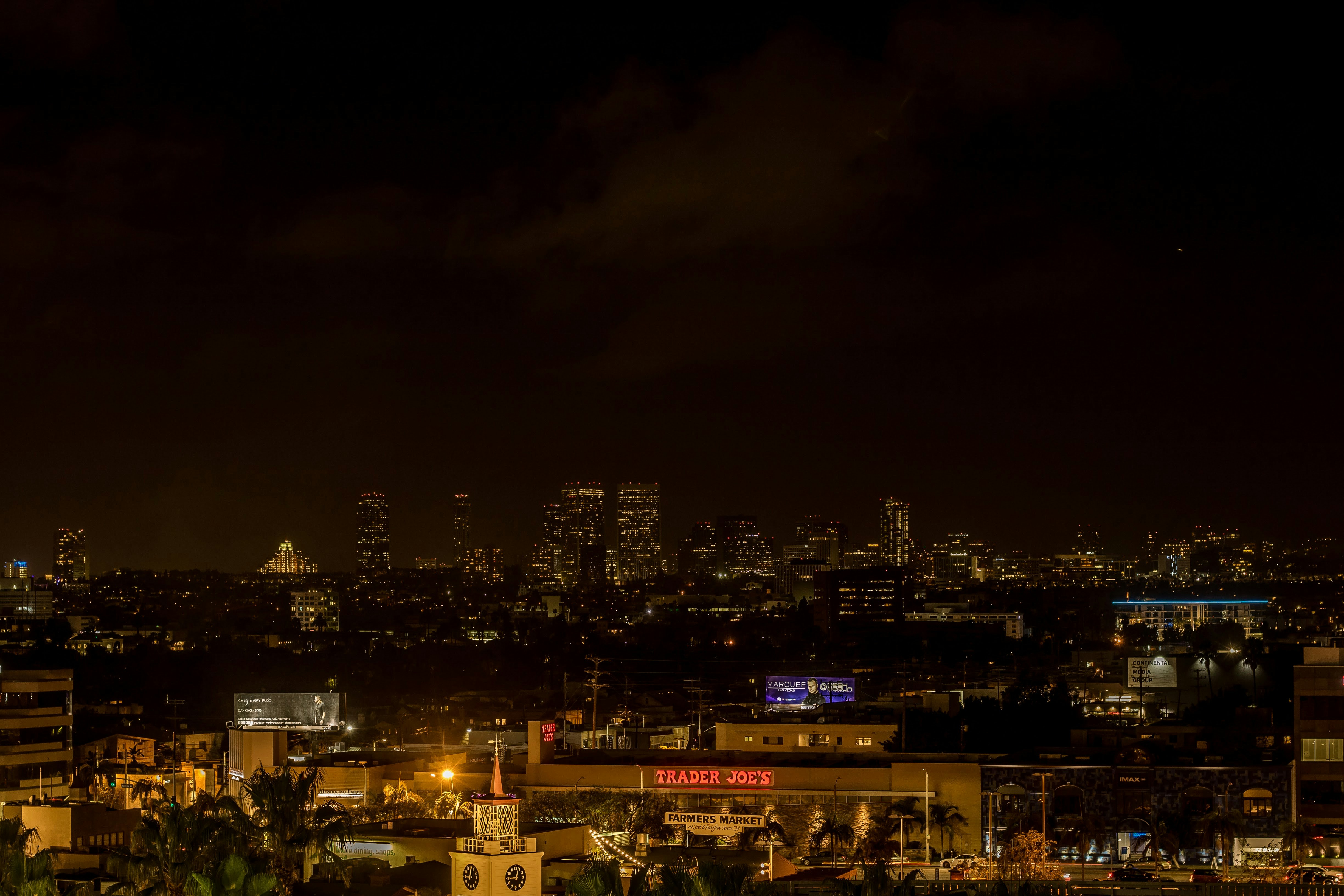 City with high rise buildings during night time photo – Free Brown ...
