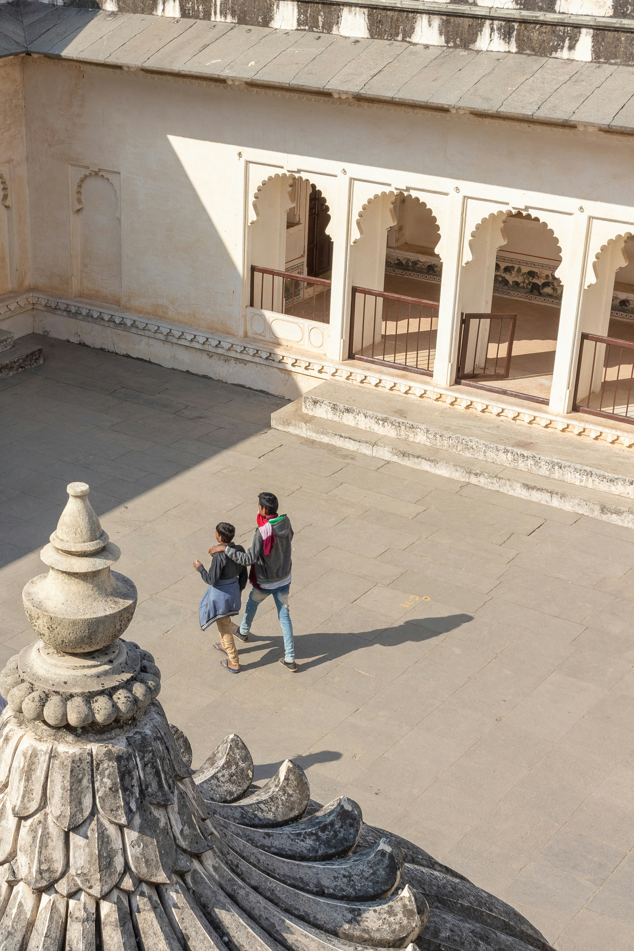 Sunlit Mughal Arcade: A Quiet Moment Above the Courtyard