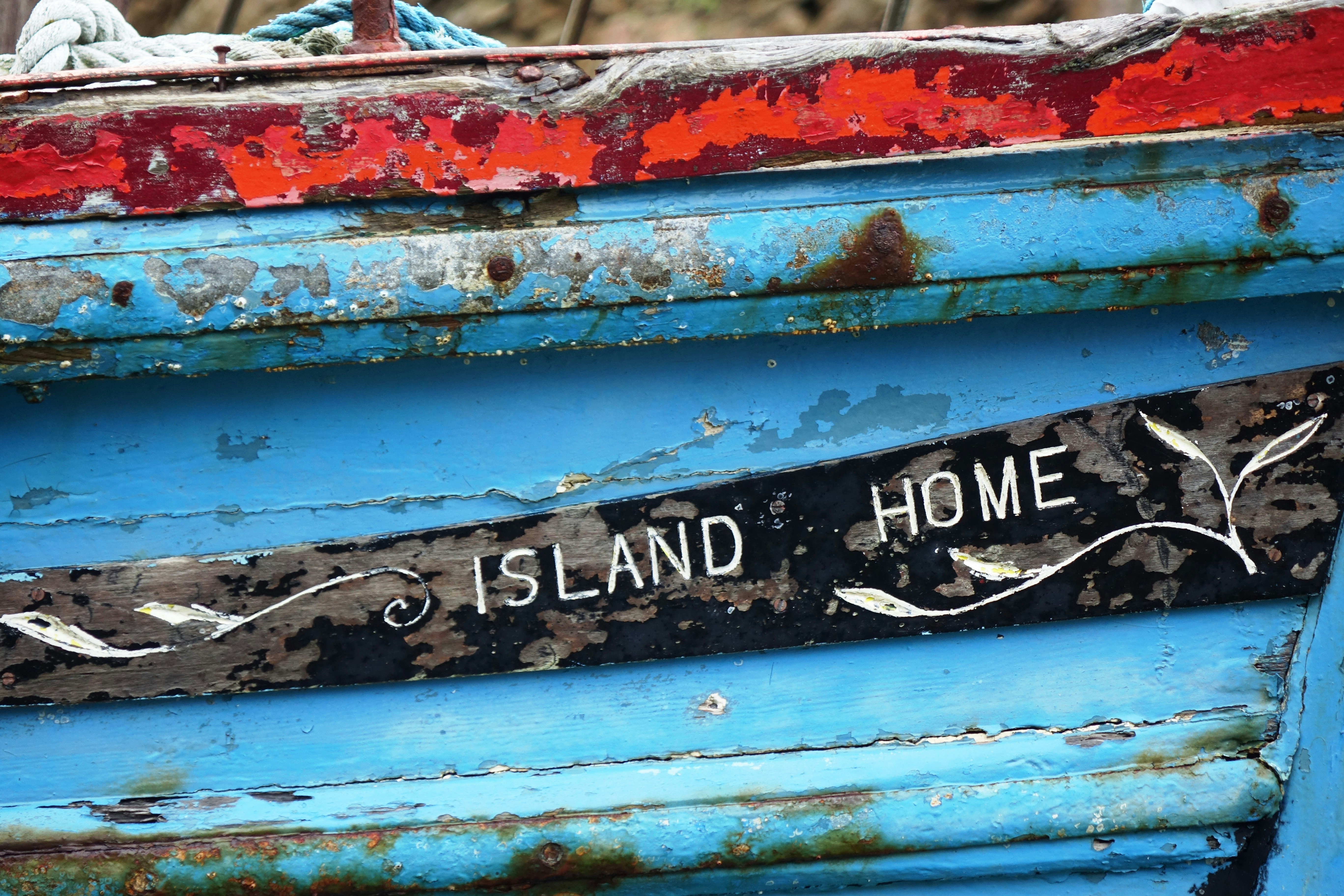 Island Home Sign on a Weathered Blue Hull