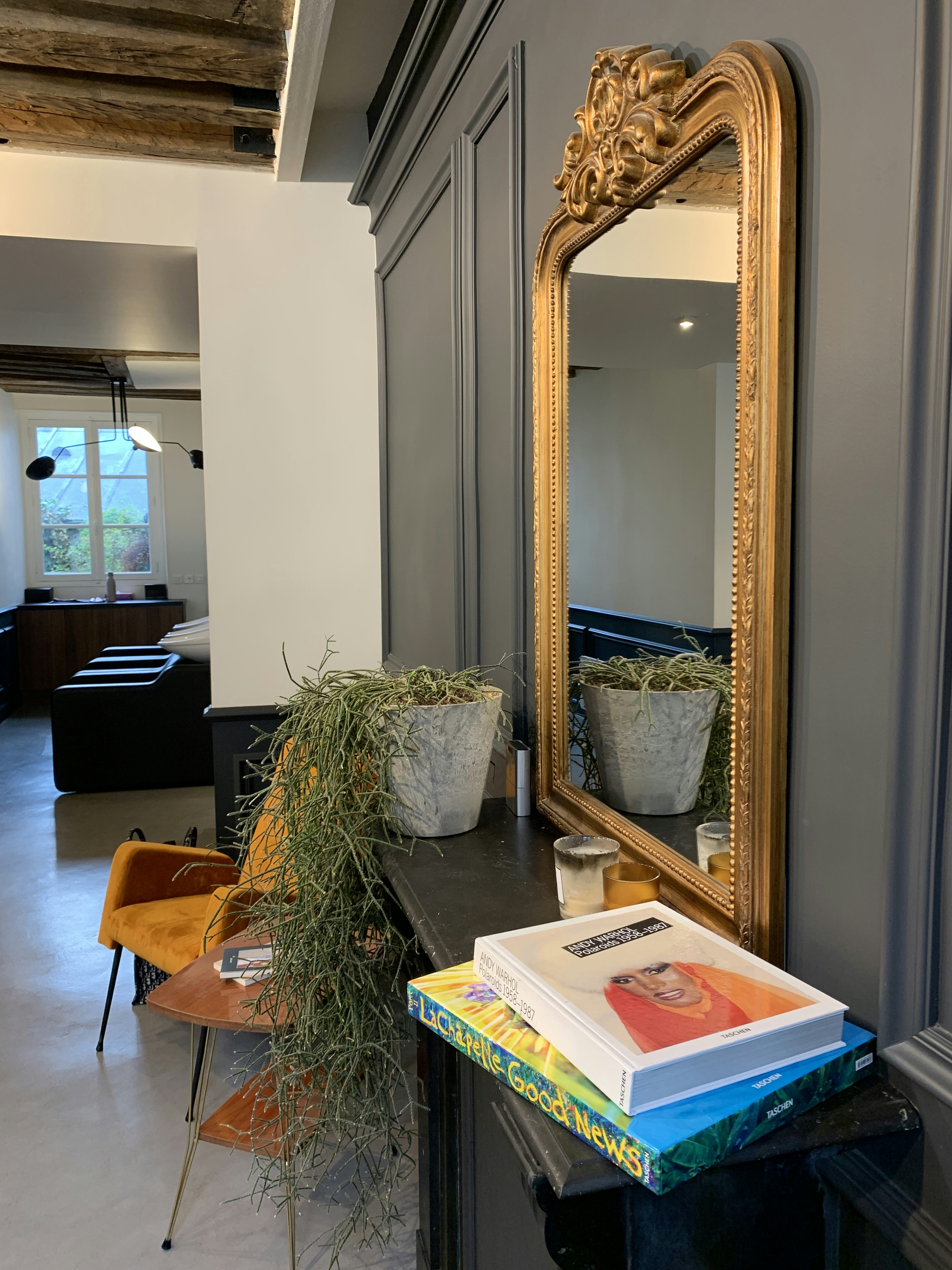Reflected Elegance: A Marble-Mankled Hallway Mirror Quietly Anchors a Reading Nook