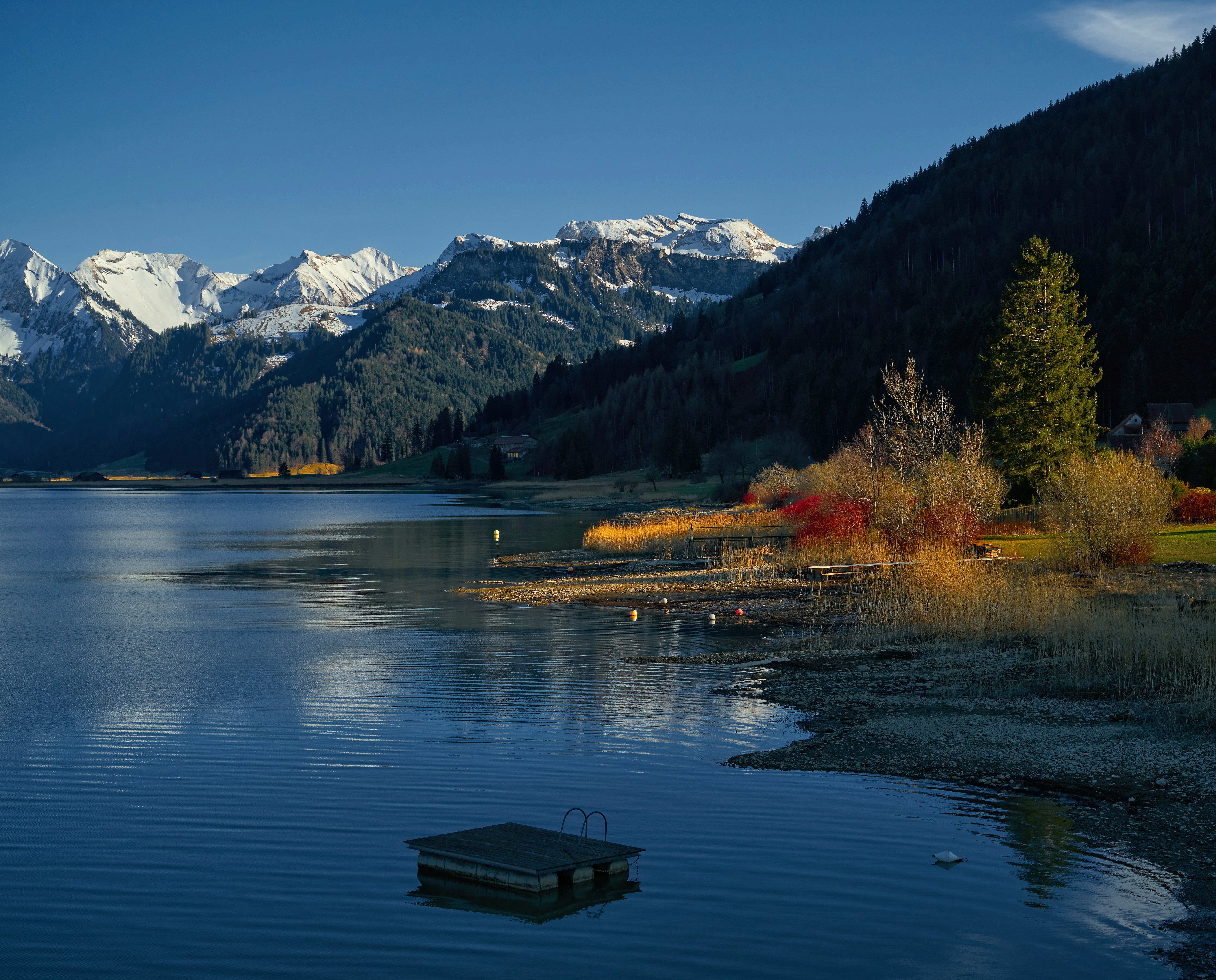 Floating Dock on a Glacier-Blue Lake Under Snow-Crowned Peaks