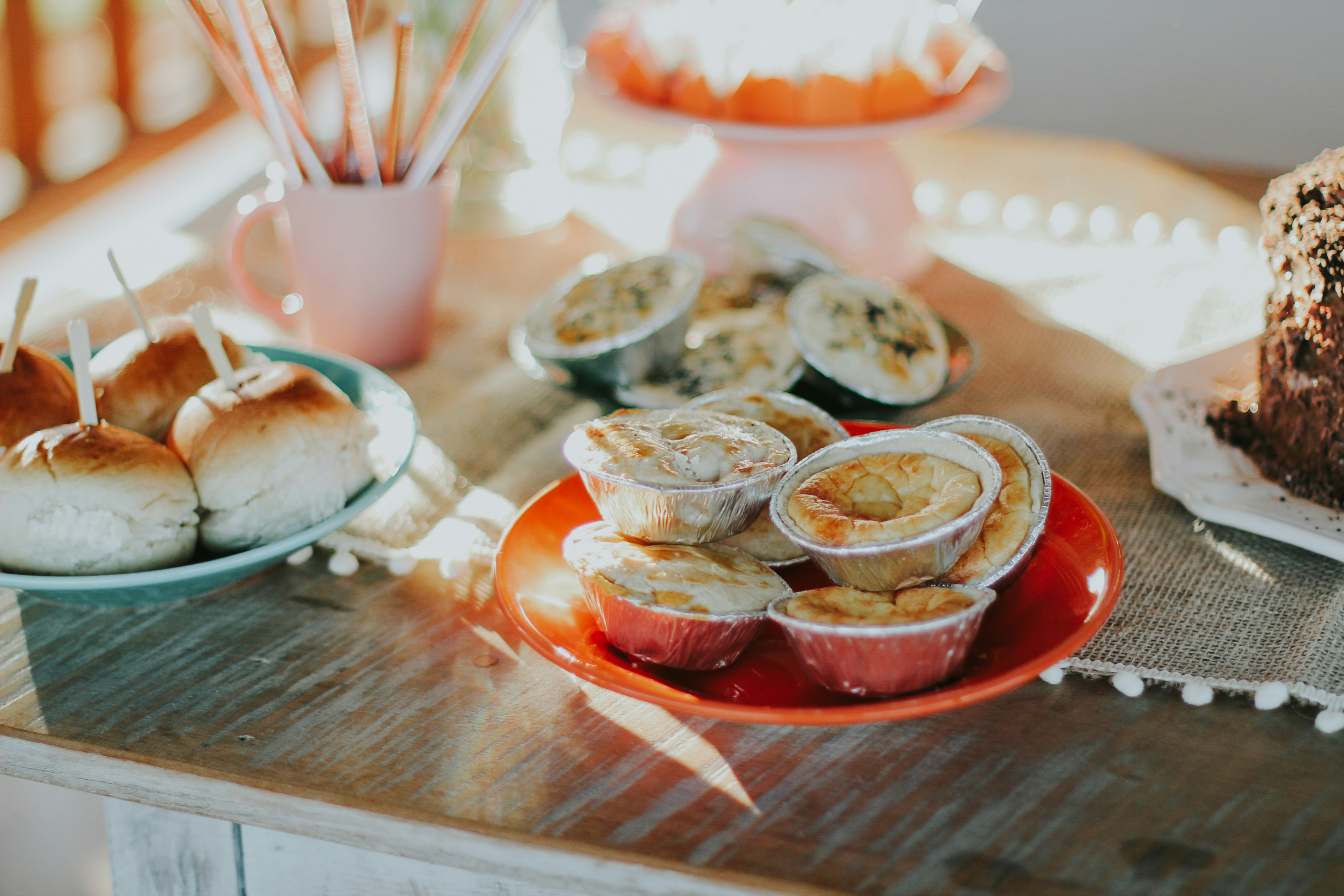 Sunlit Brunch Spread: Tiny Tarts and Pastries on a Rustic Table