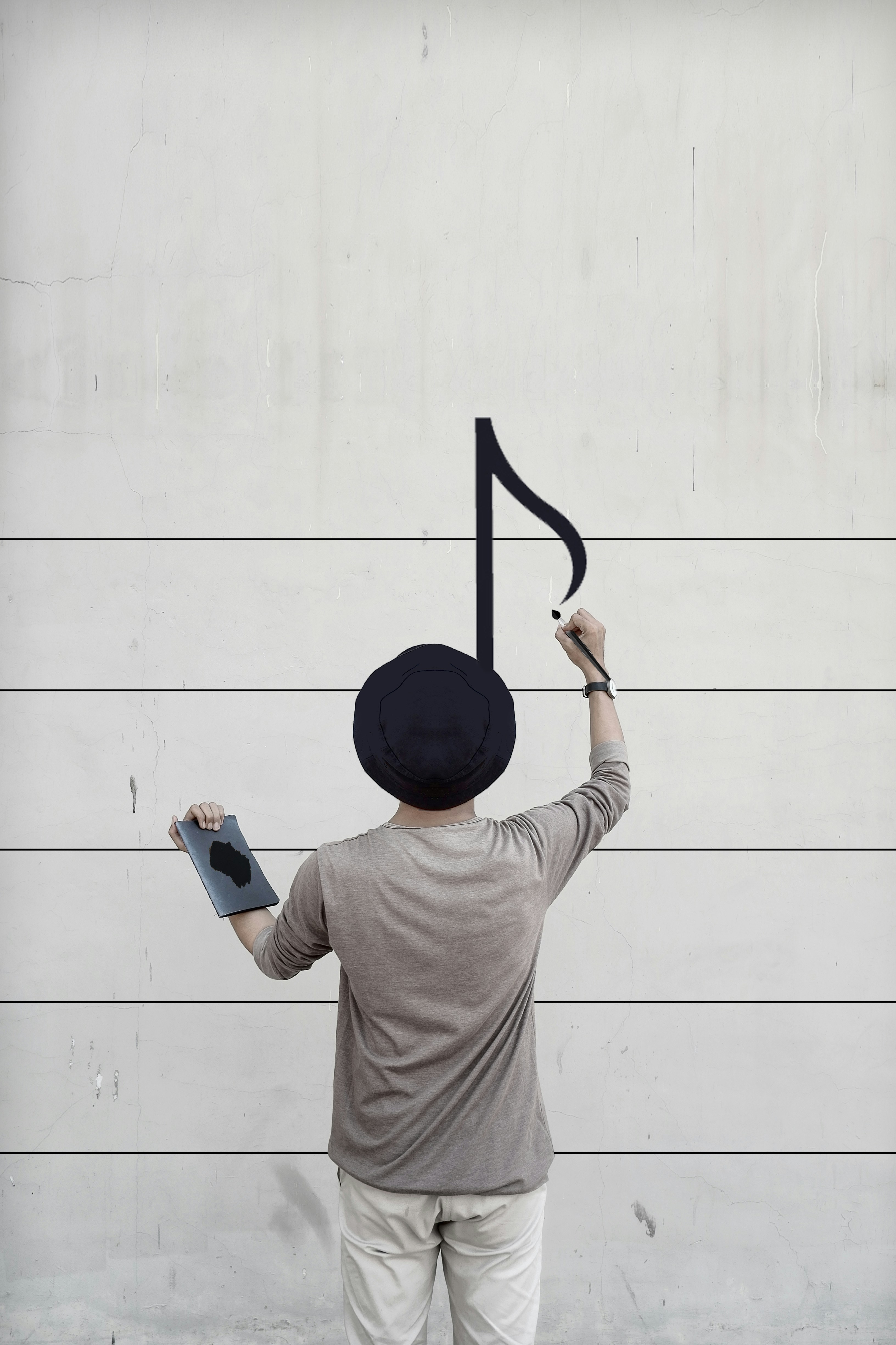 Tracing a Quarter Note on a Pale Wall