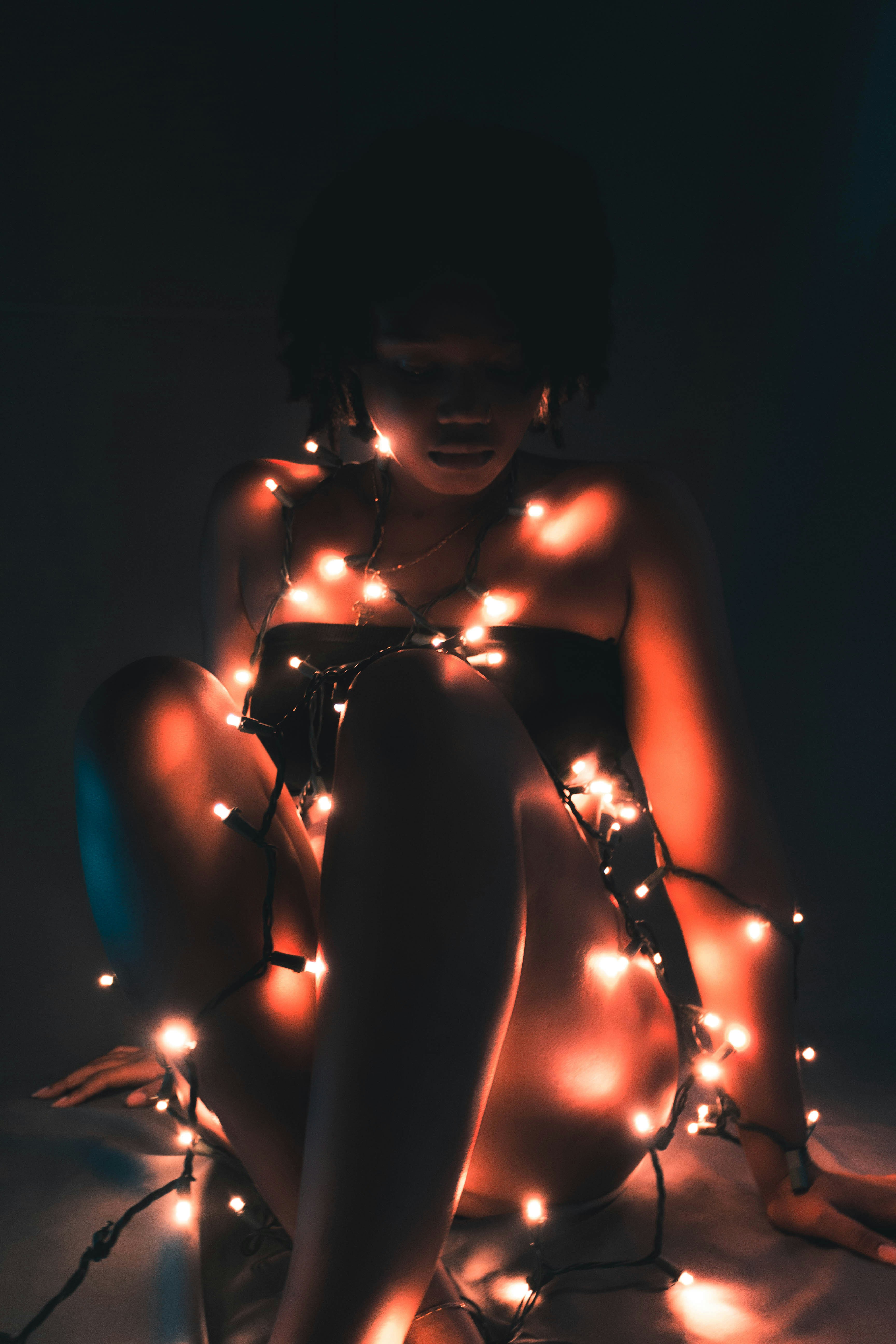 Embered Silhouette: A Portrait Wrapped in Fairy Lights